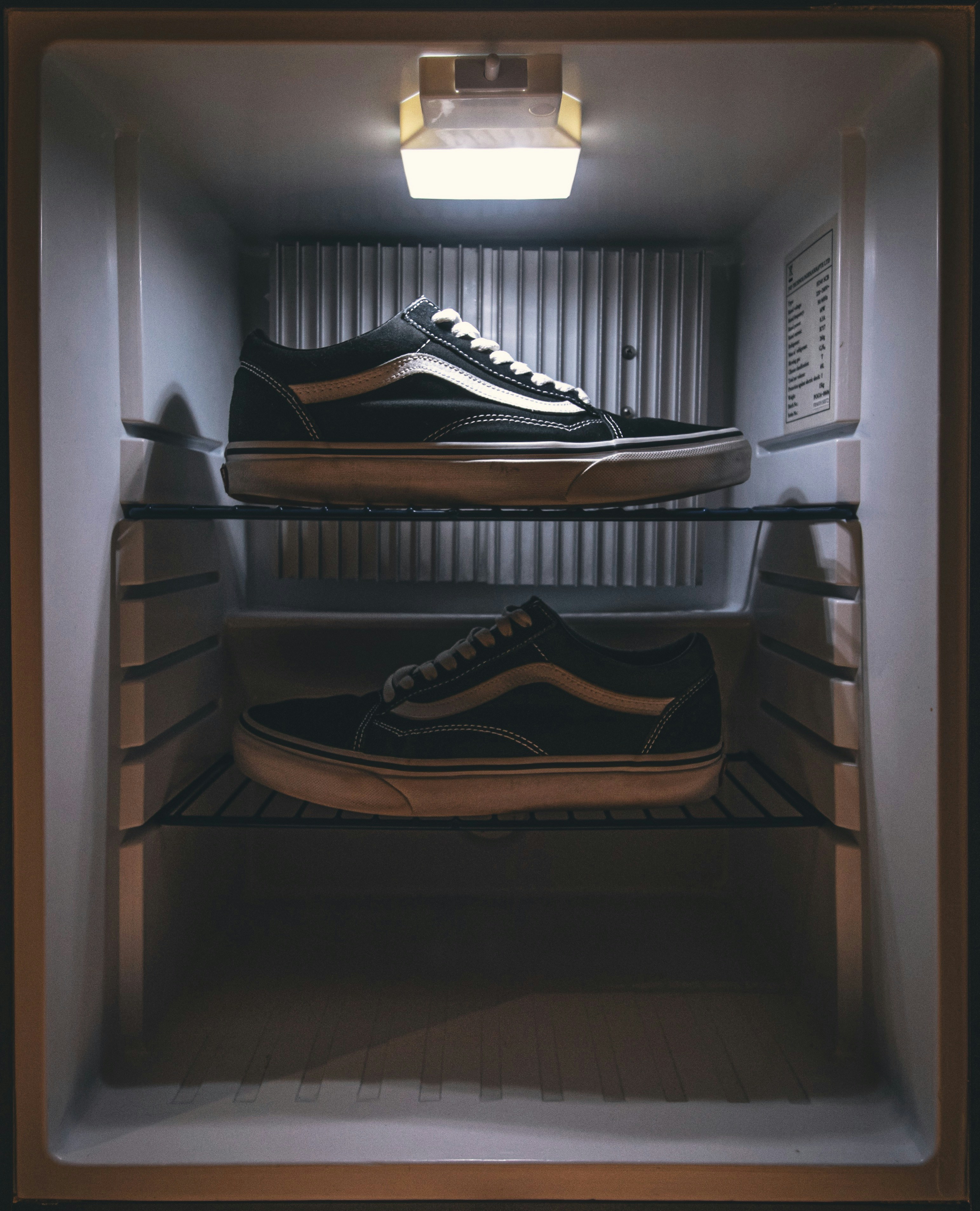 pair of black Vans low-top sneakers on rack