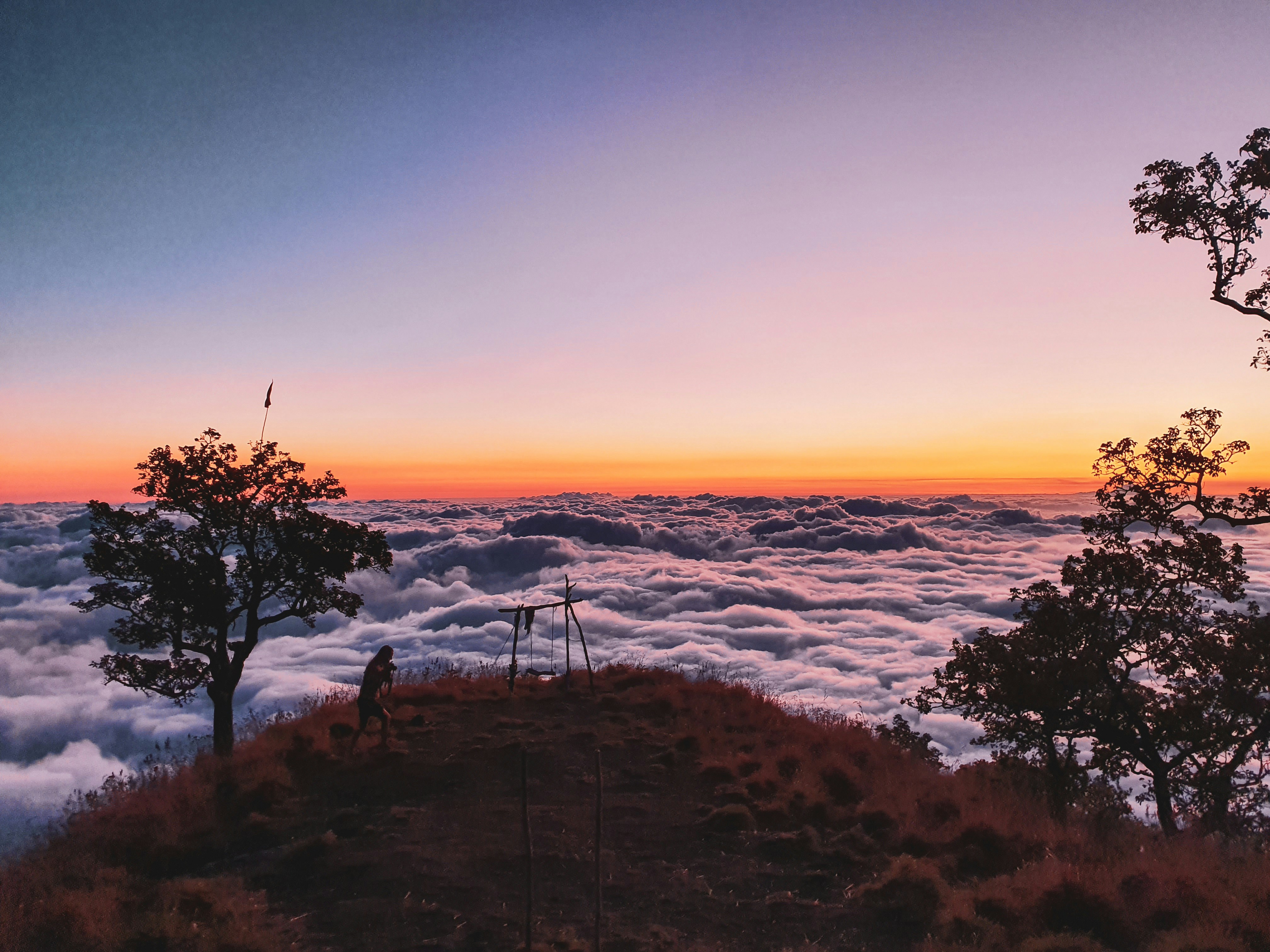 Ridge Top at Dawn: A Lone Photographer Over a Sea of Clouds
