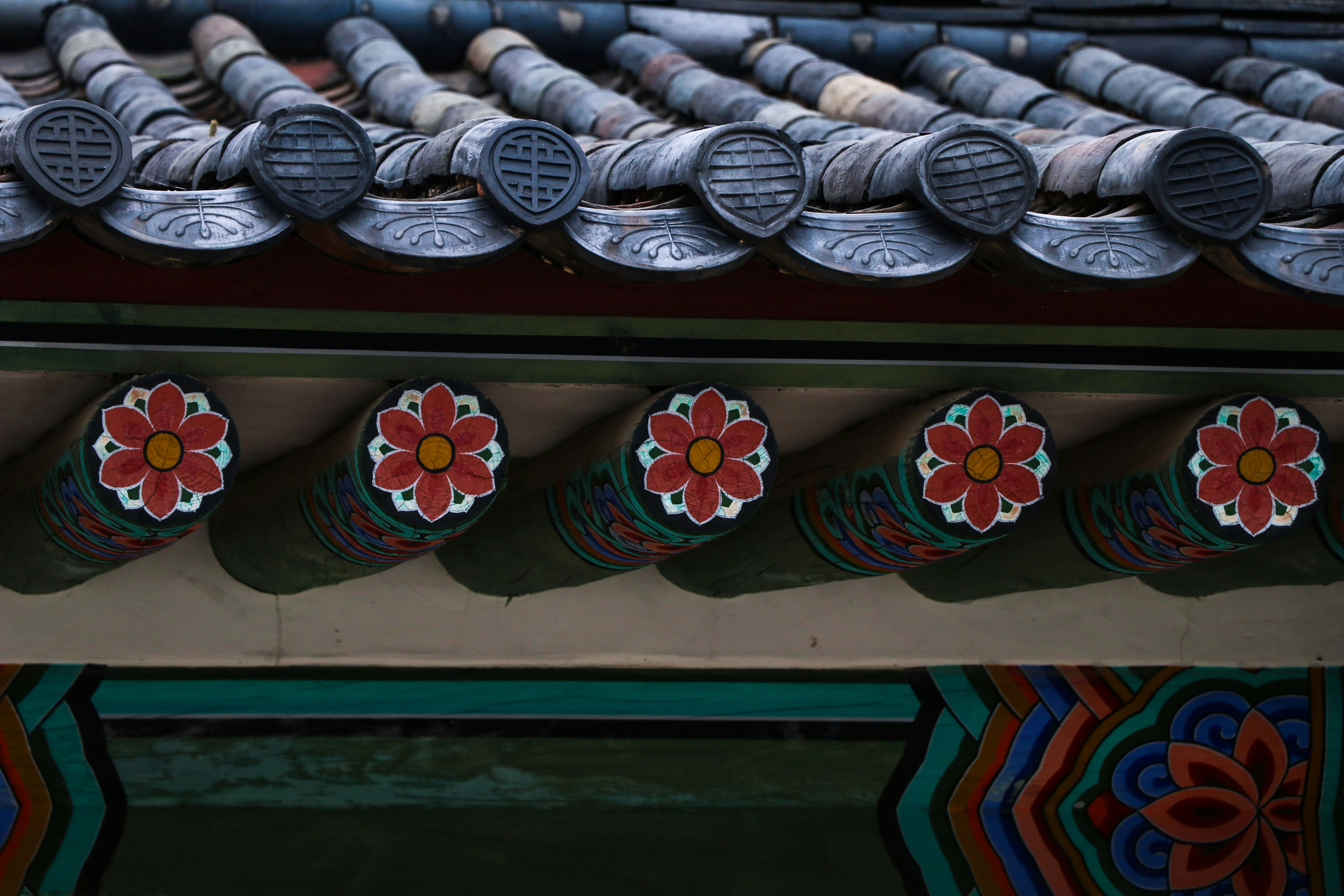 Rosette blossoms crown the ornate tiled eave