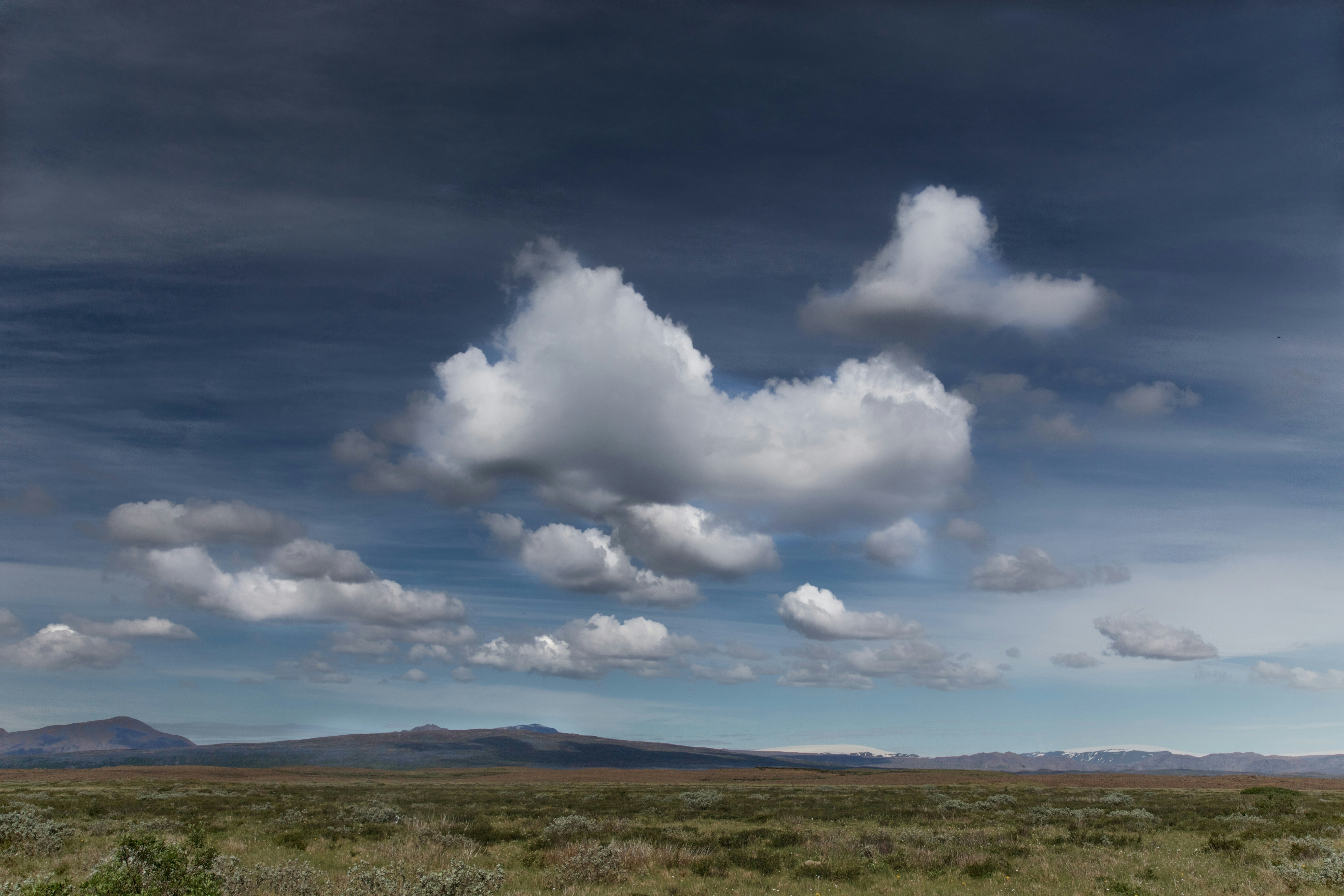 Green field under clouded sky photo – Free Grey Image on Unsplash
