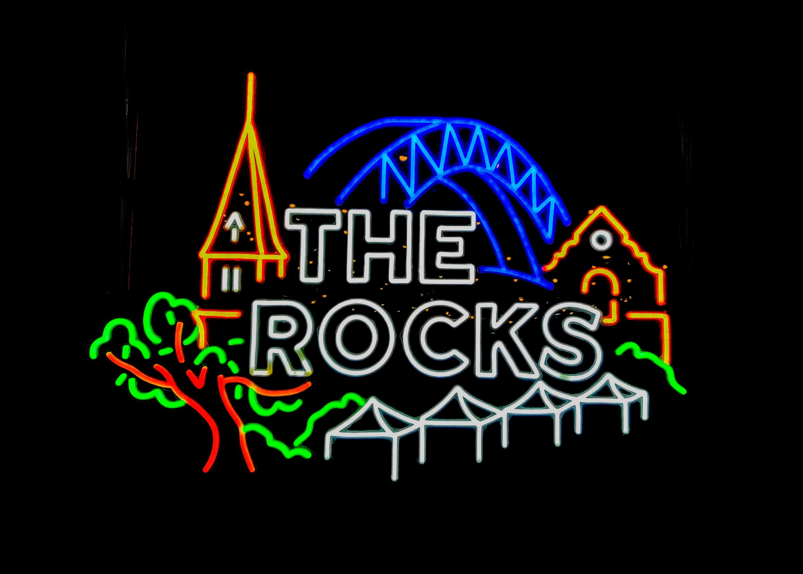 Neon Chronicle of The Rocks: Night Signage Glow