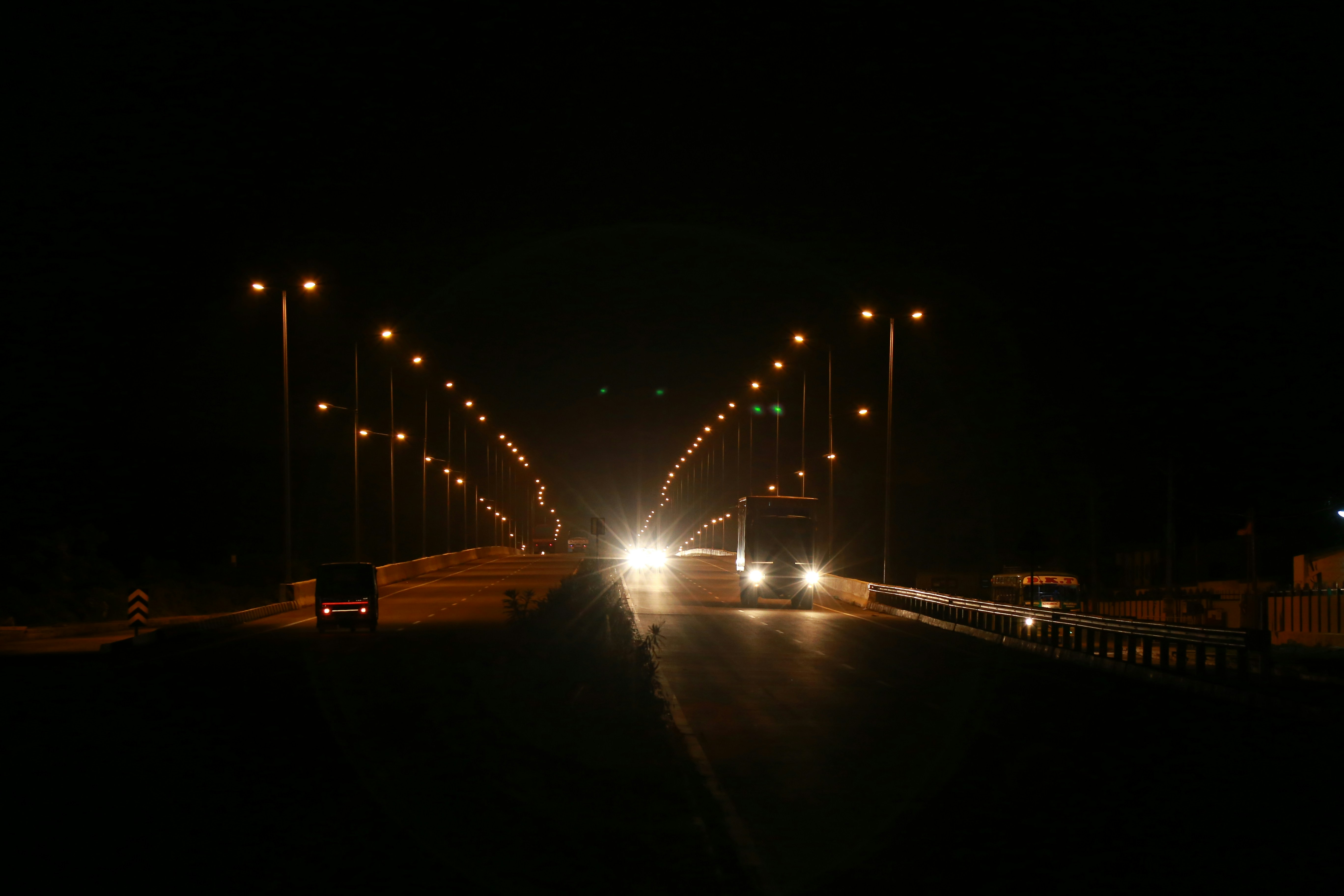 a car driving down a road at night