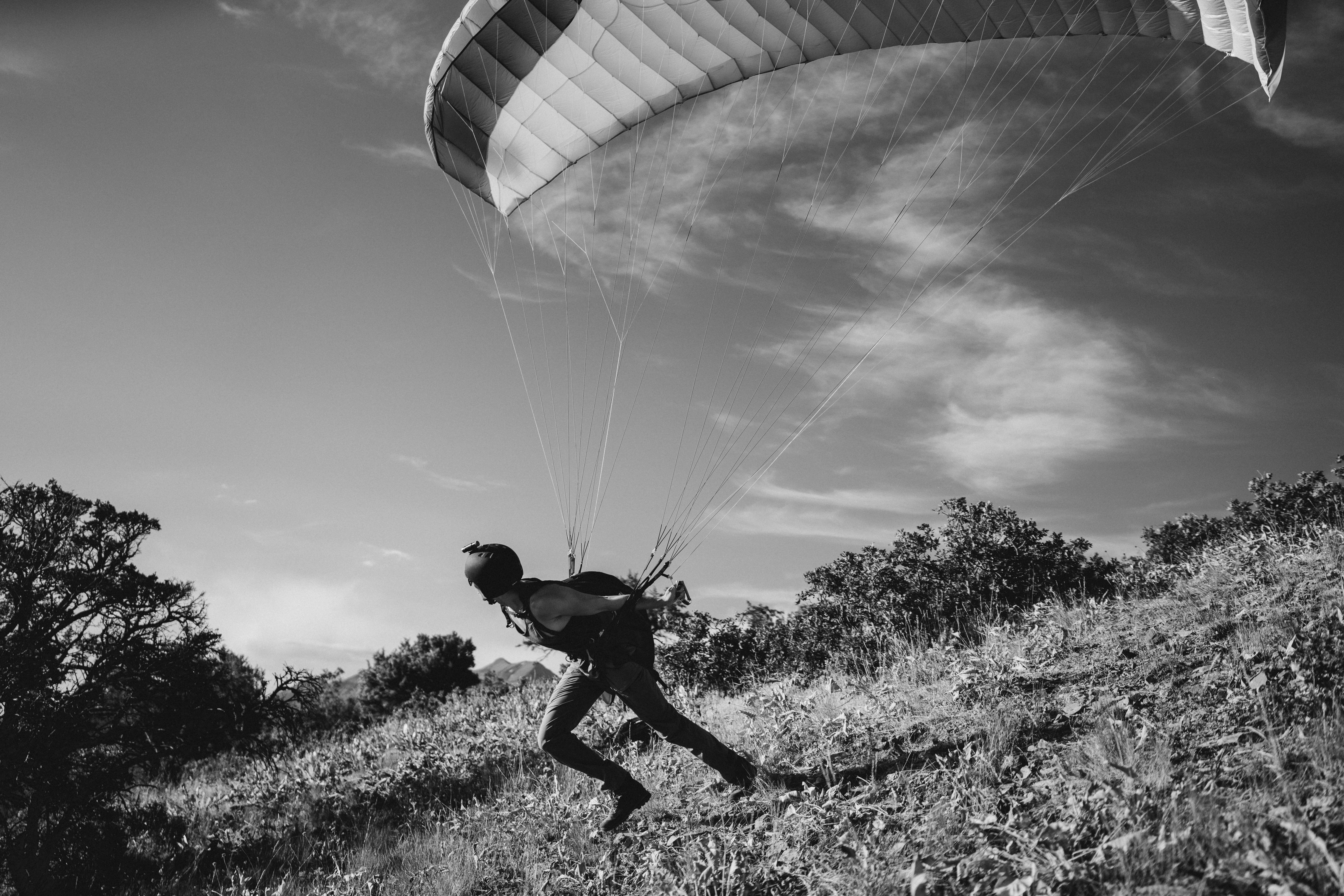 Grayscale photography of person with parachute photo – Free Grey Image ...