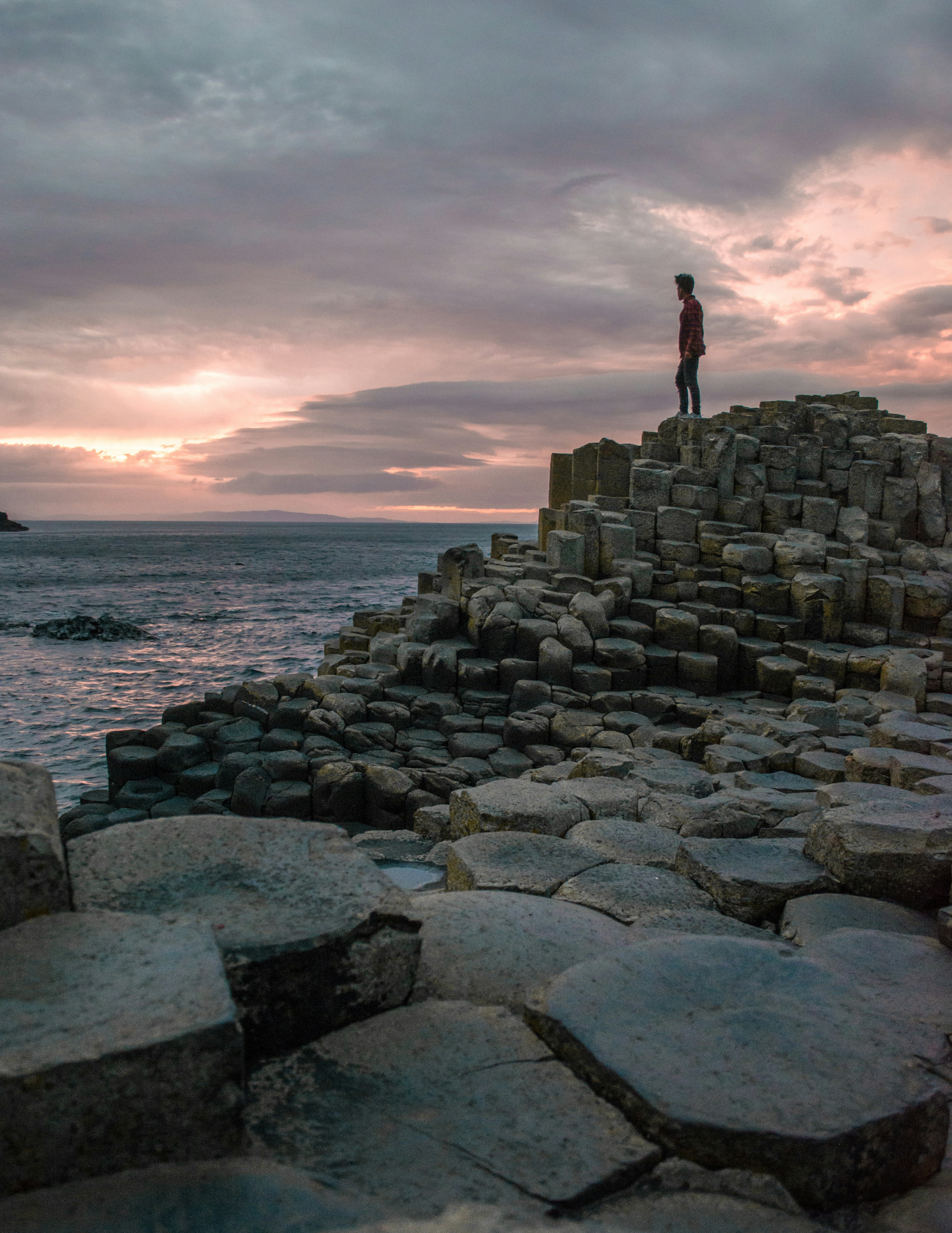 Lone Silhouette on a Basalt Staircase at Sunset