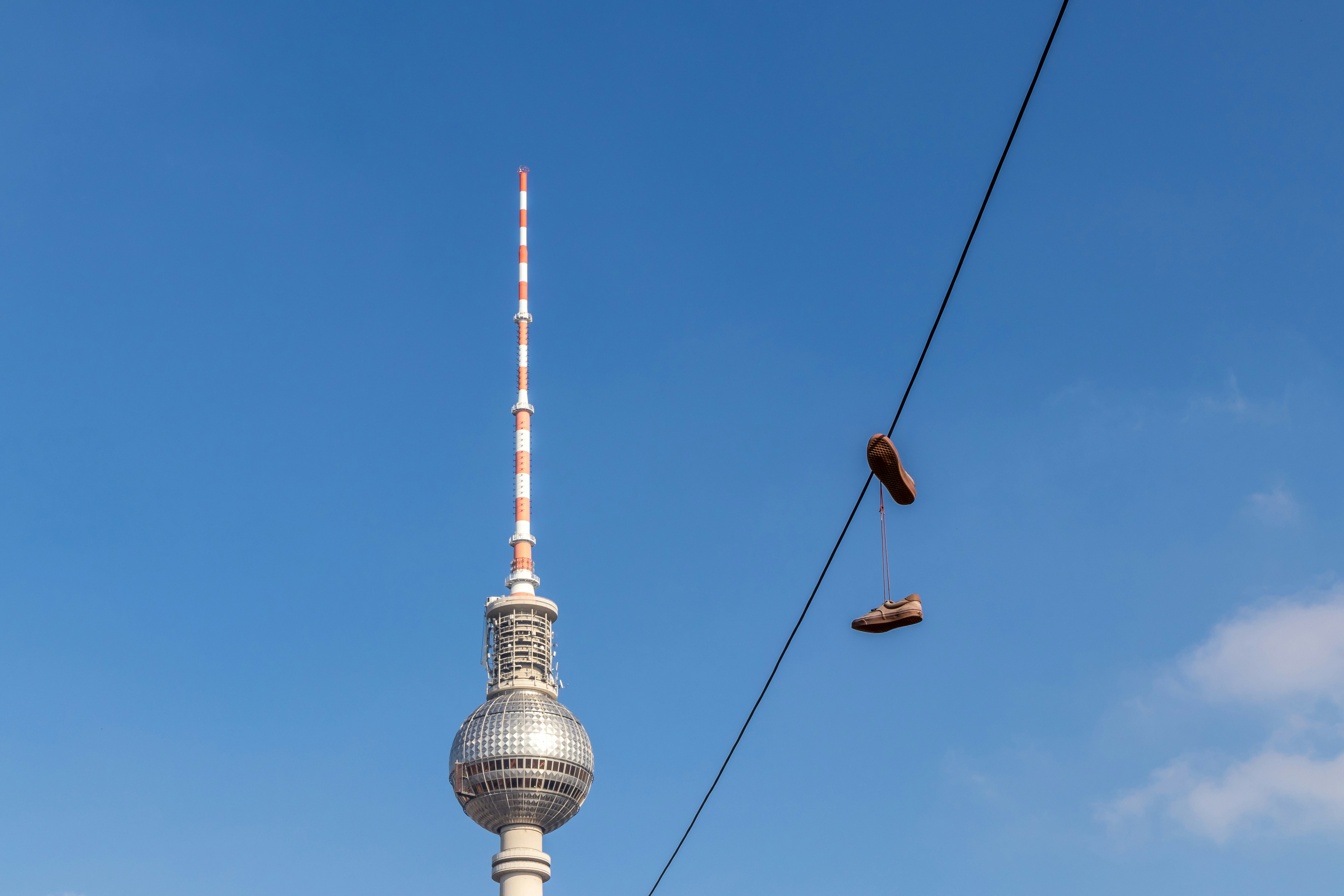 pair of brown shoes on cable wire