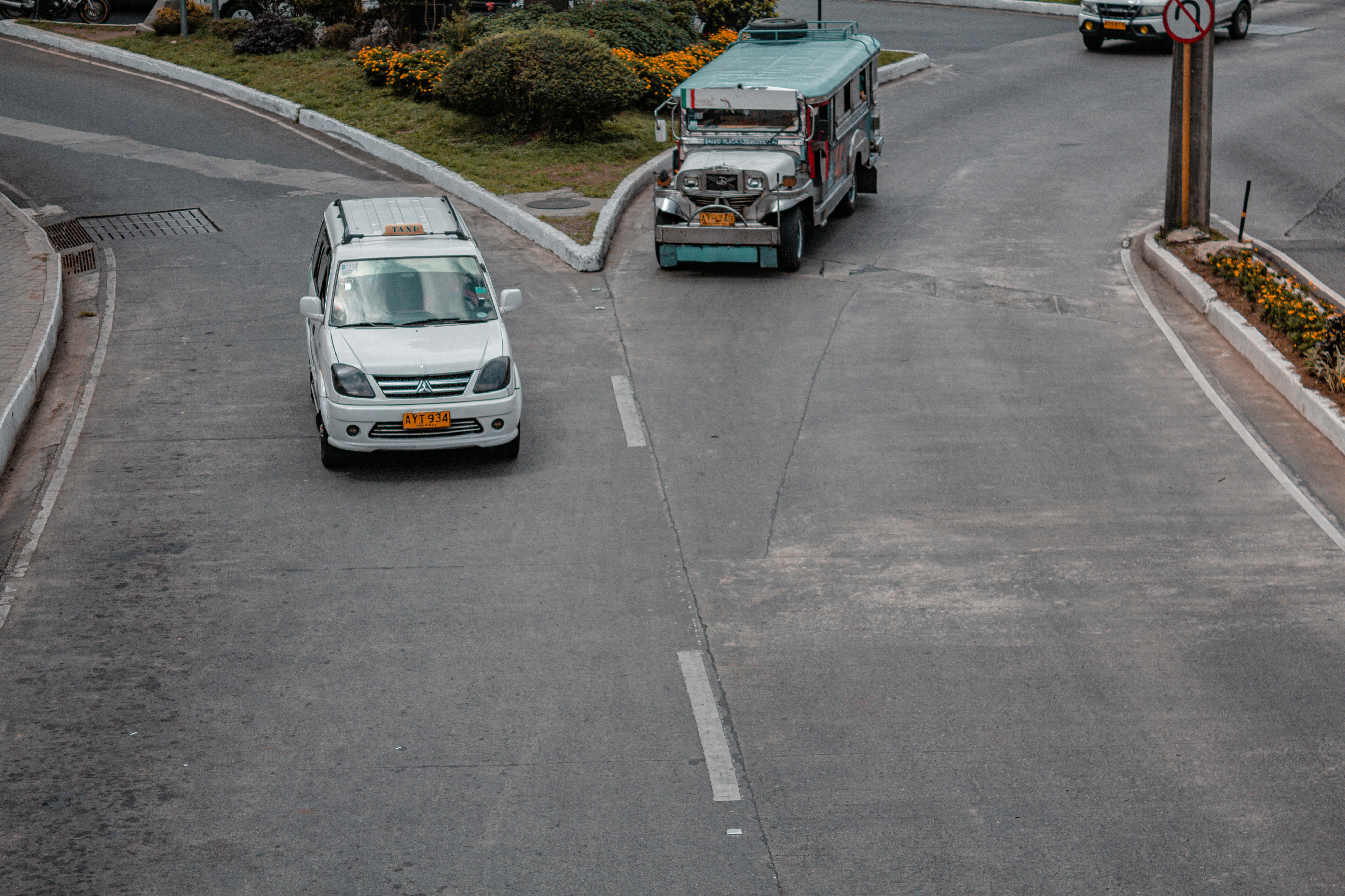 White car and jeepney on road photo – Free Car Image on Unsplash
