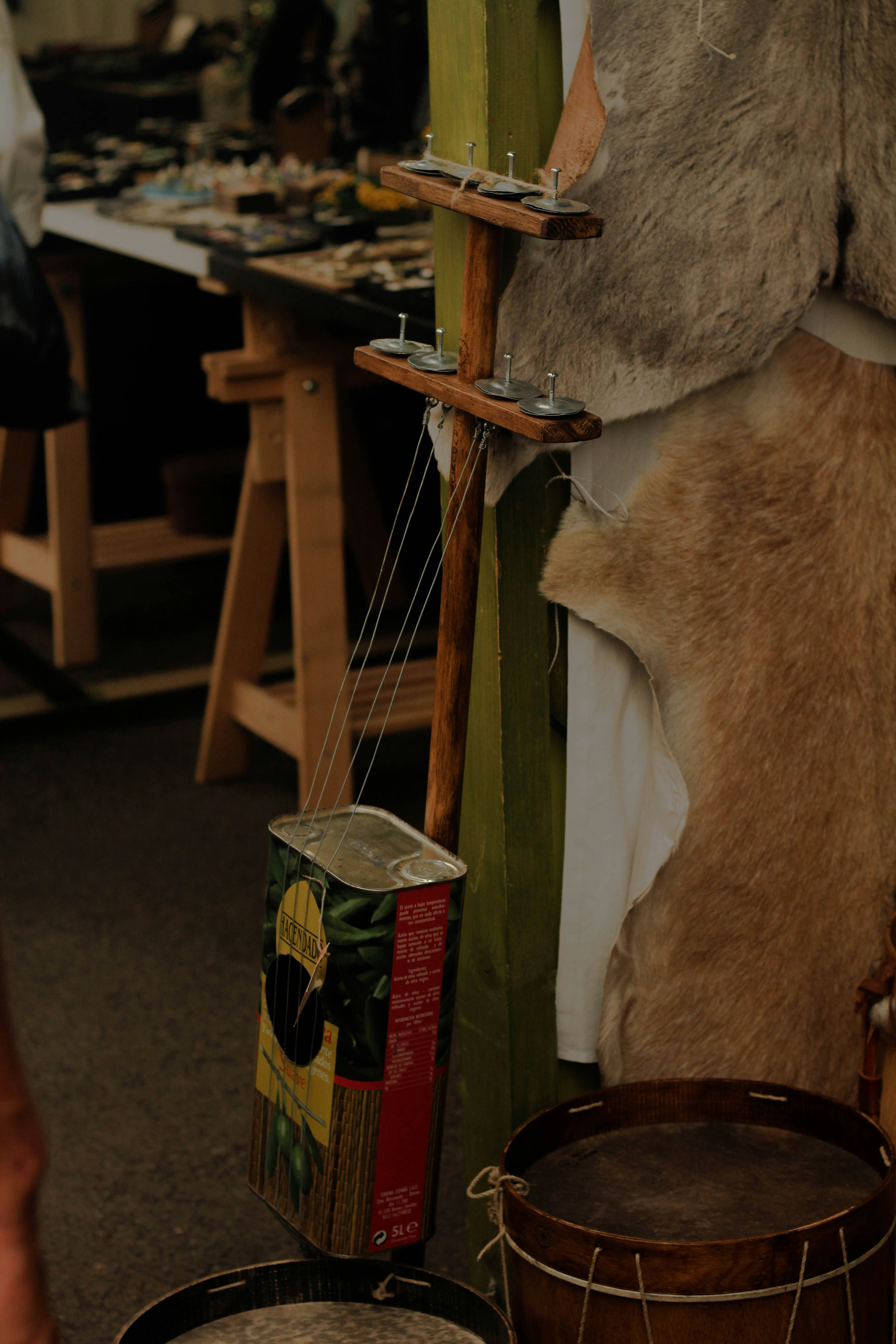 Strings of Color: A Suspended Tin Cart Amid Fur and Wood