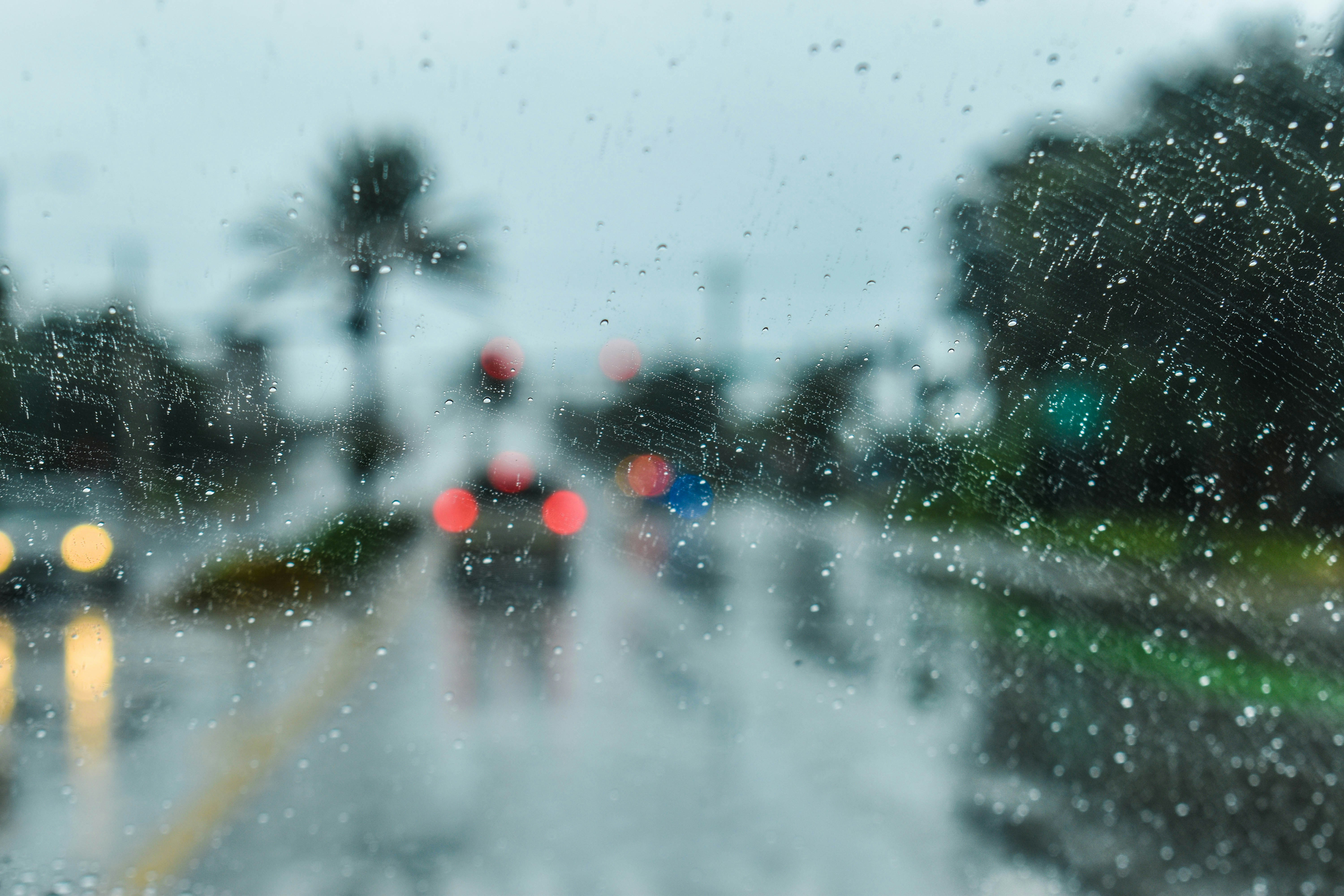 Rain on Glass: Distant Taillights Blur Across a Quiet Highway