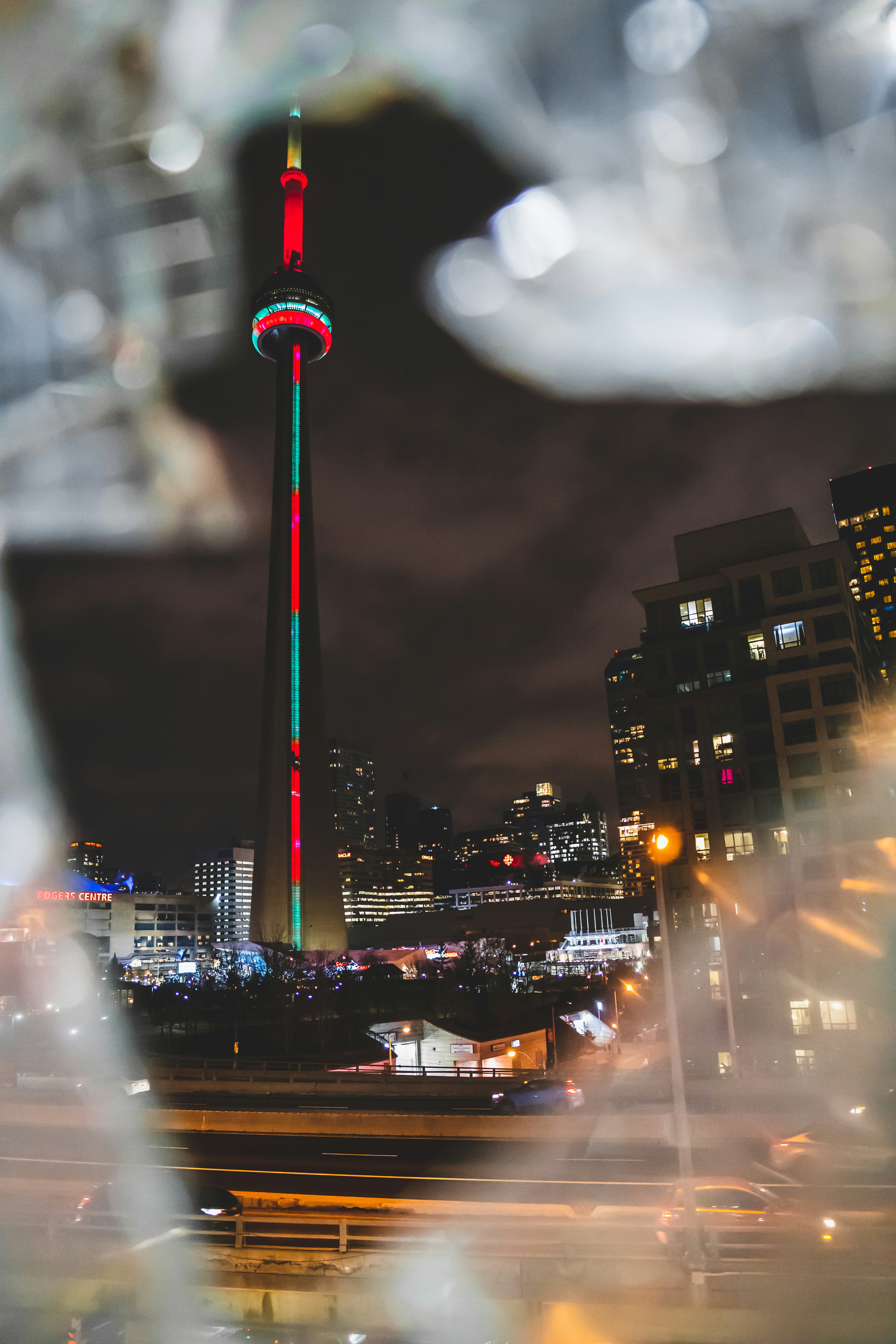 Neon Spire Pierces Velvet Night Over a City of Reflections