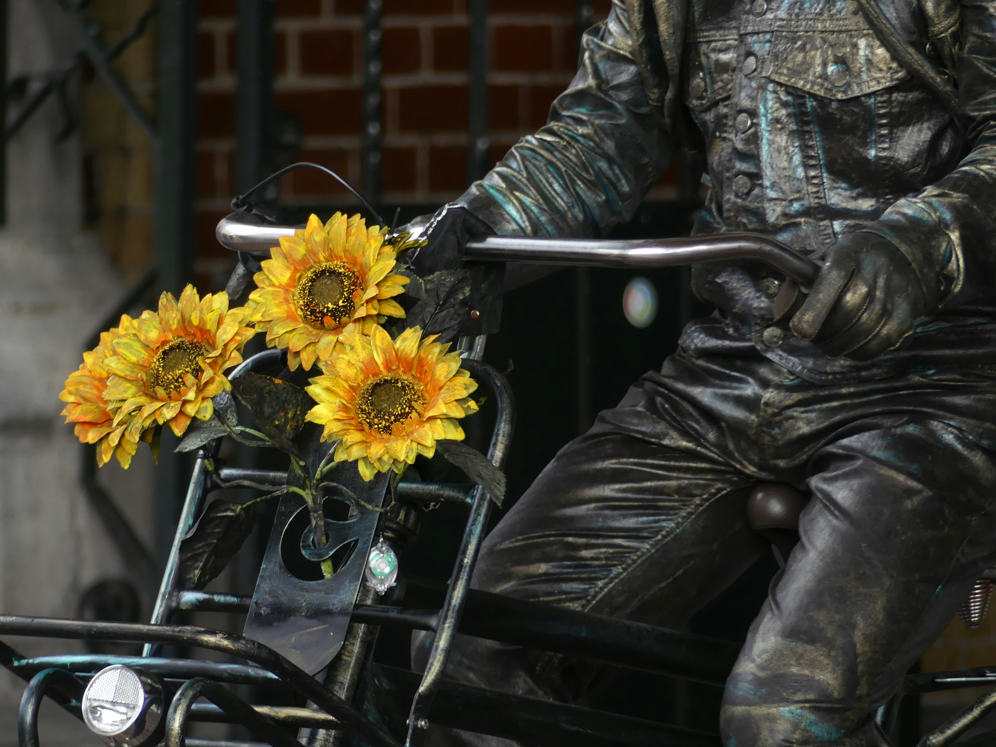 Sunflowers on a Metallic Ride: A Bronze Figure with Fresh Bloom