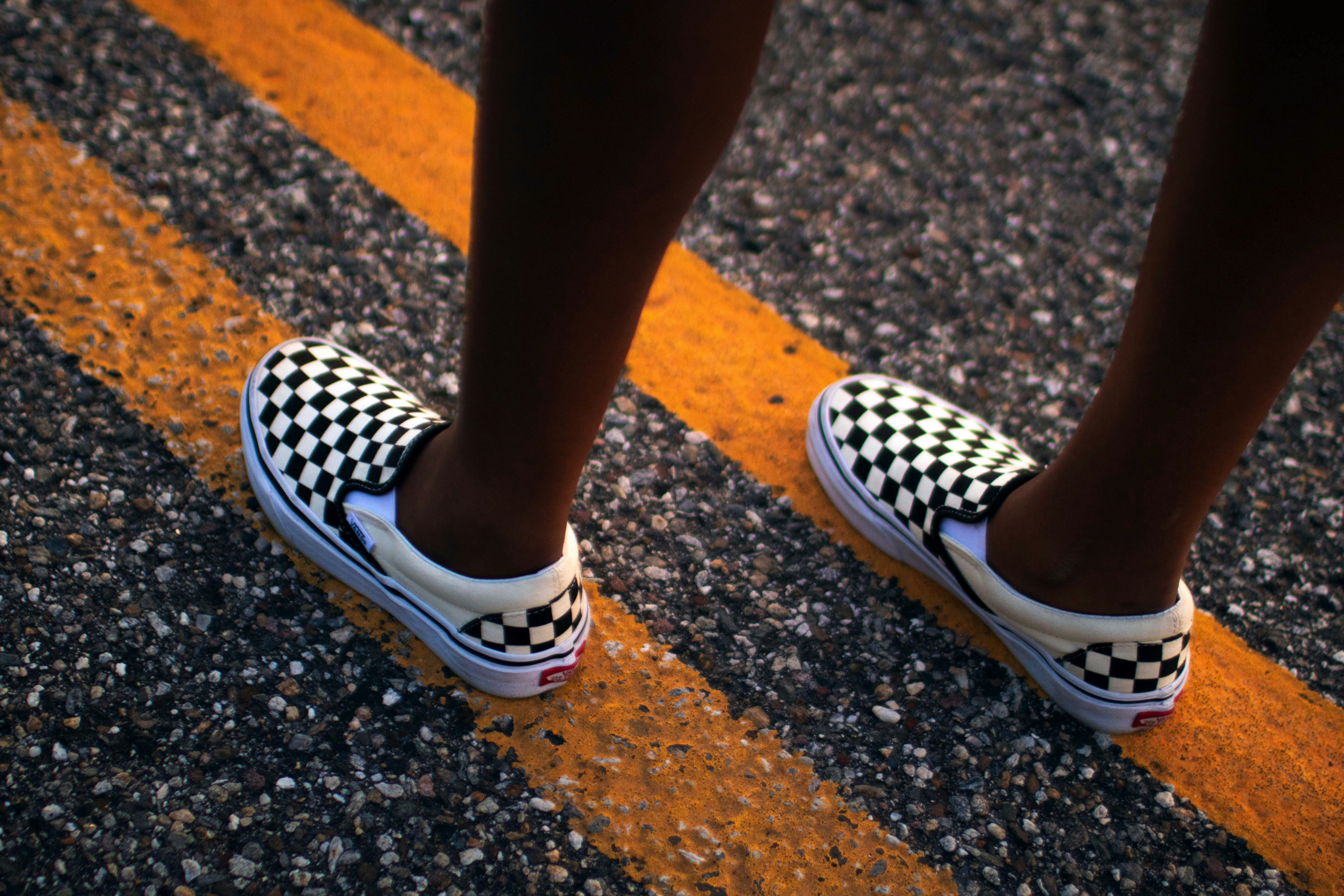 Pair of white-and-black Vans checkered slip-on shoes photo – Free Human ...