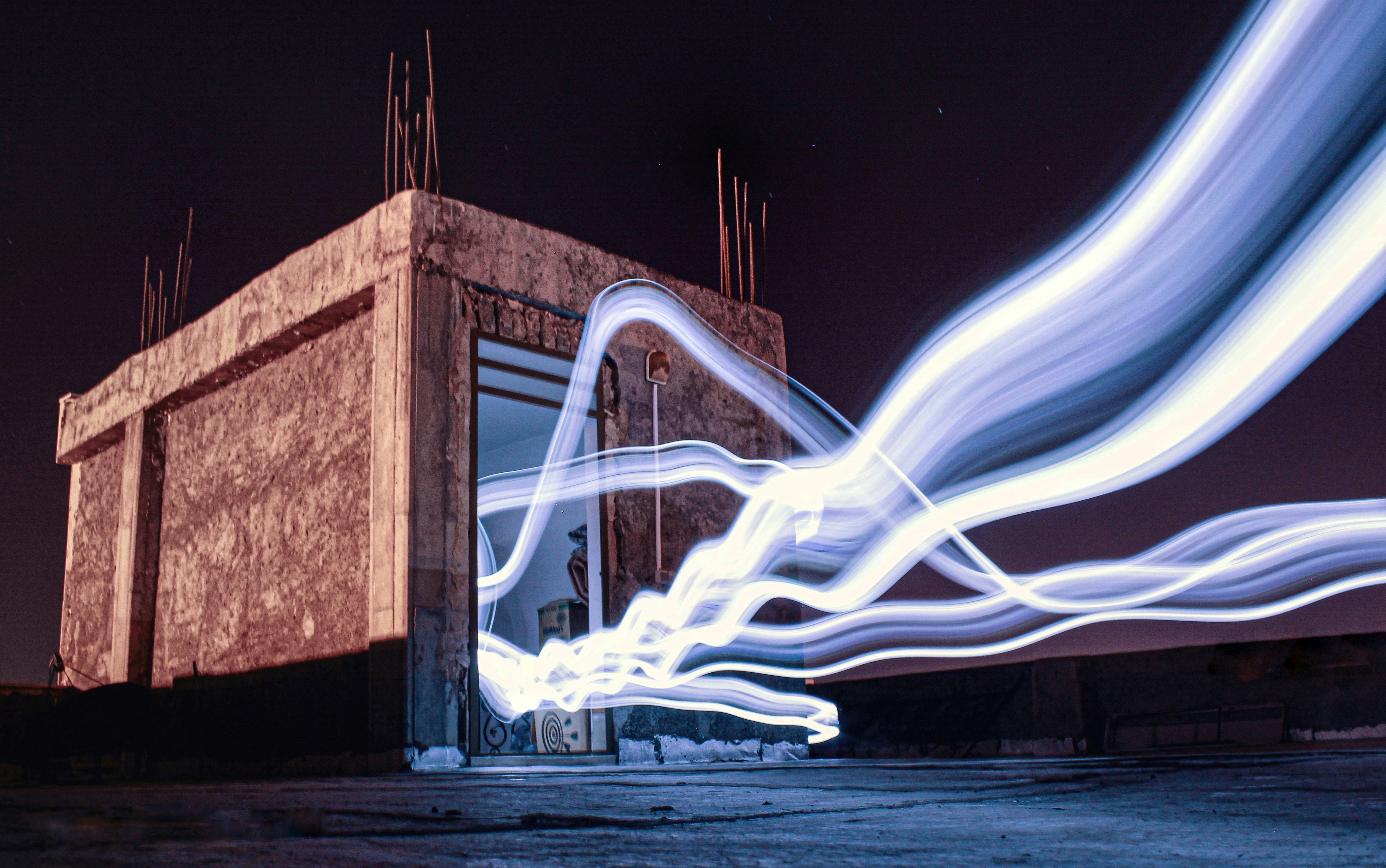 Ghostly Stream: Light Trails Embrace a Rooftop Structure