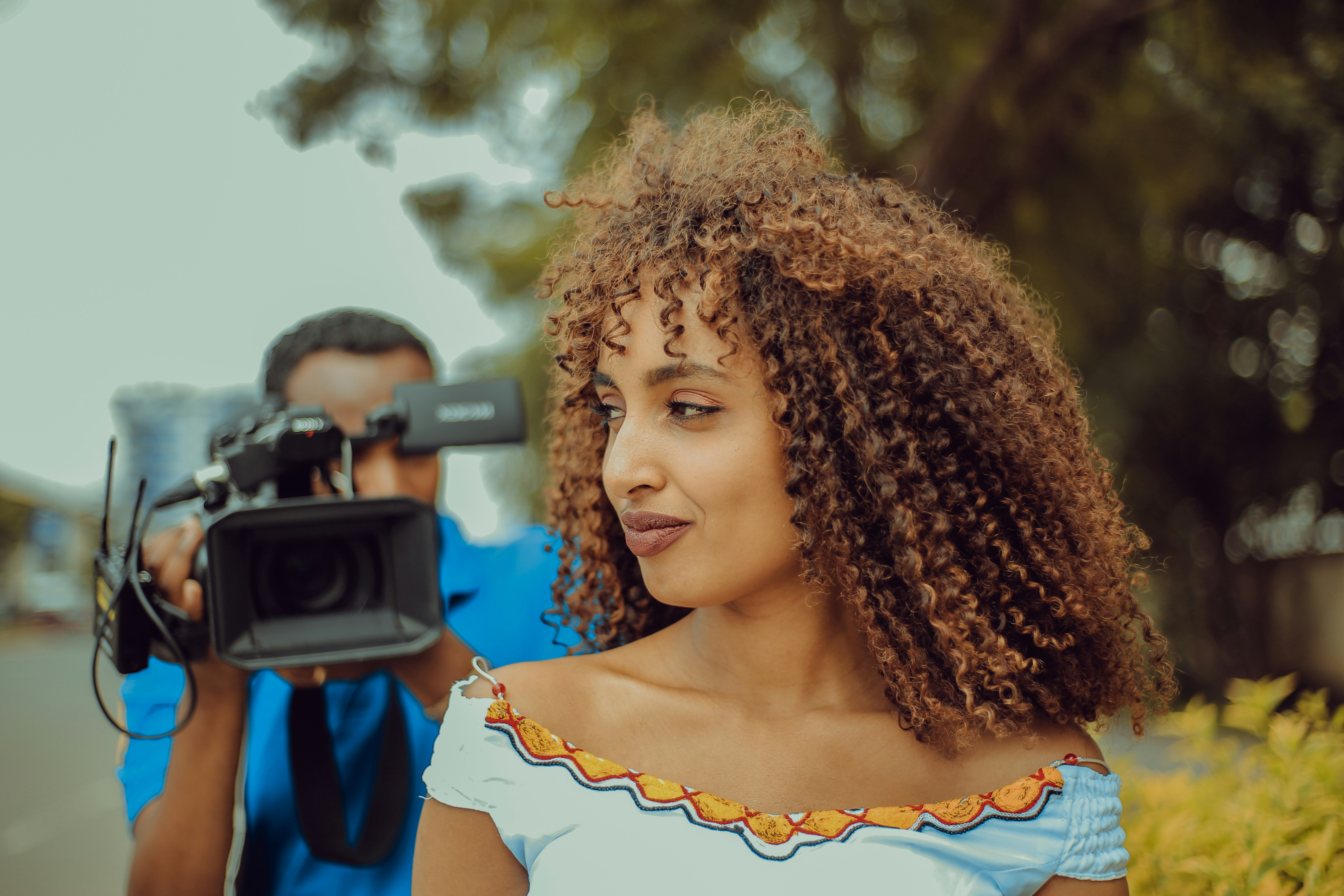 Woman smiling and looking at her right in front of man using video ...