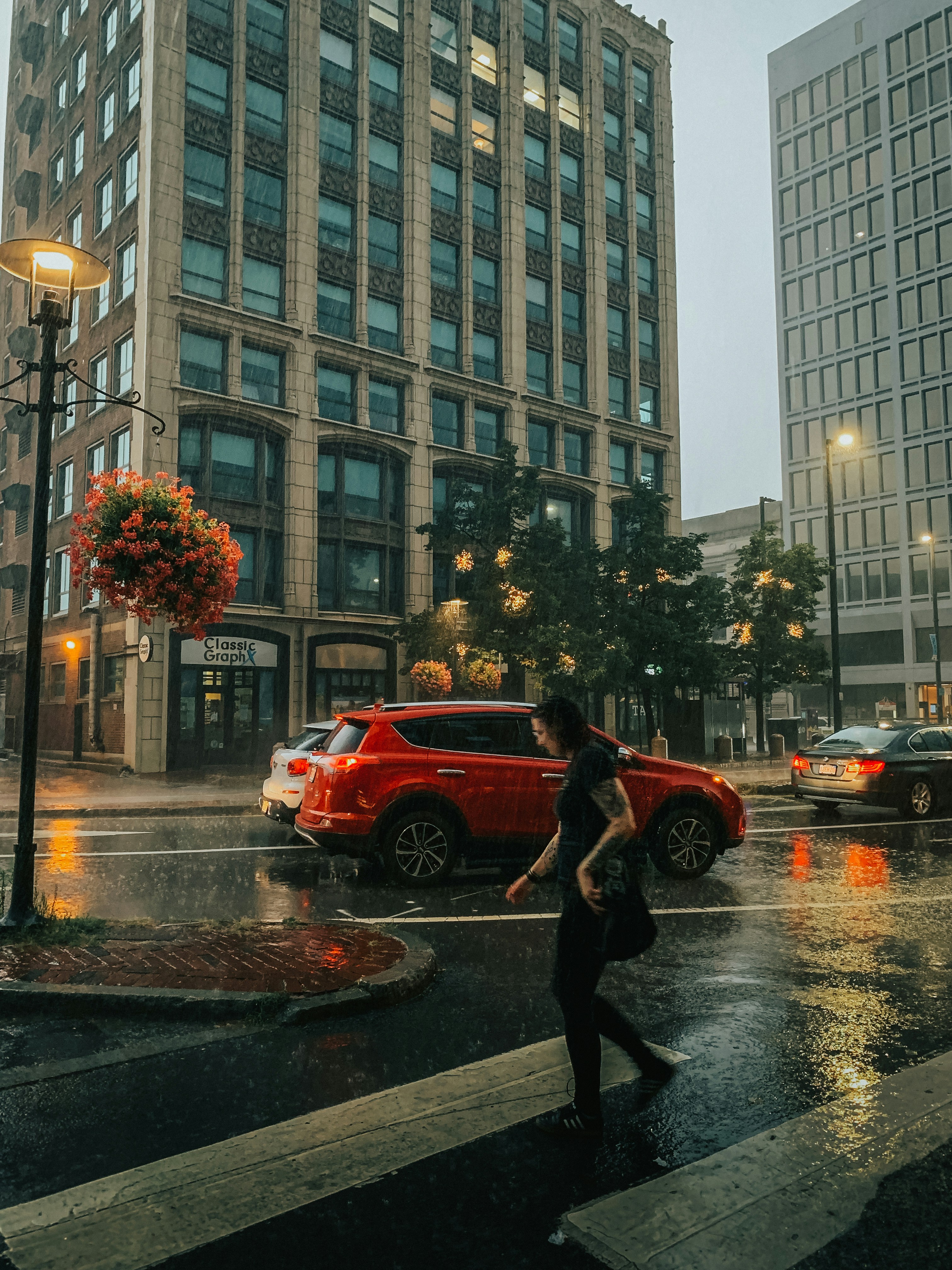 Rain-soaked Crosswalk: City Life in Motion