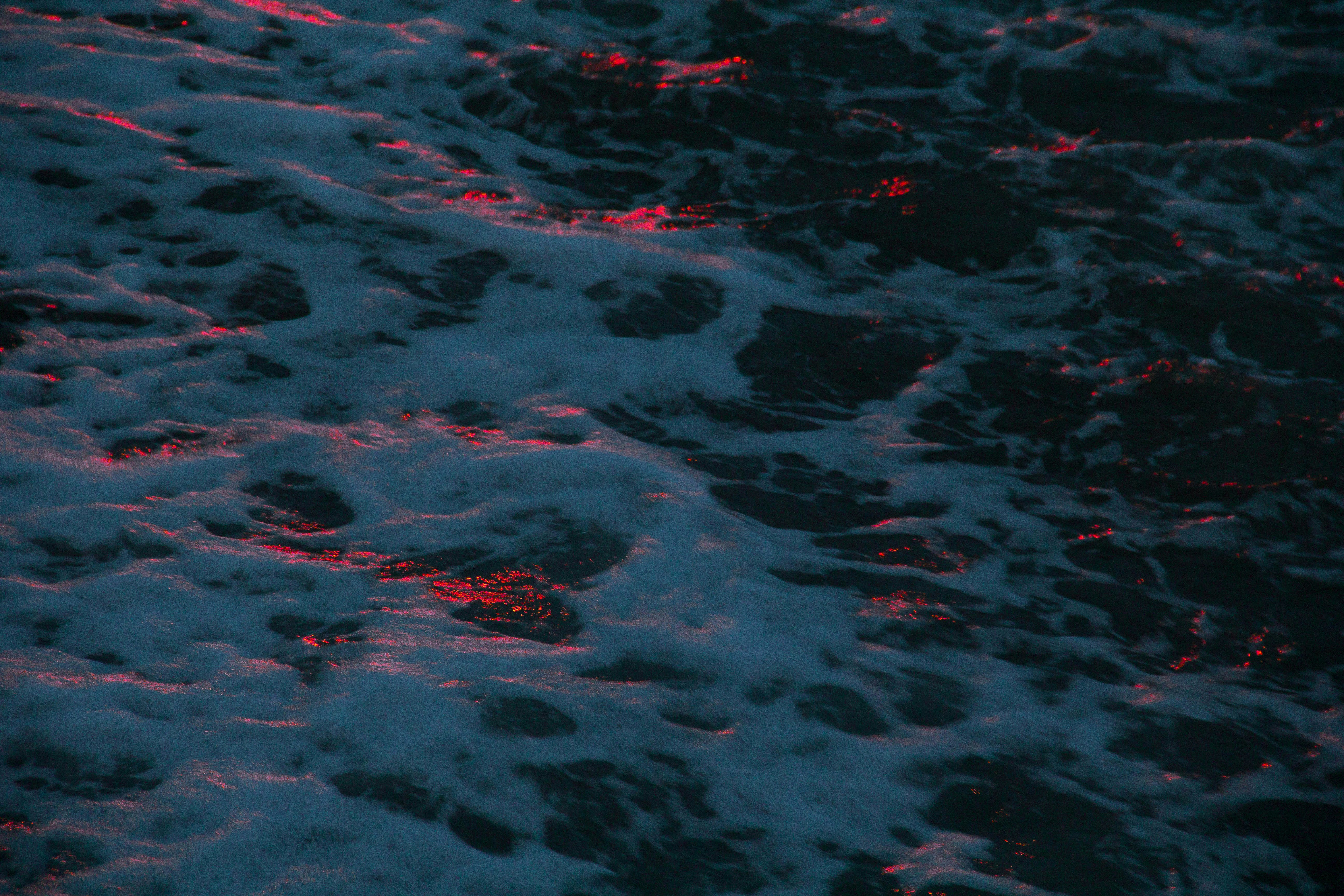 Crimson Crestlines in a Dusk-Soaked Ocean