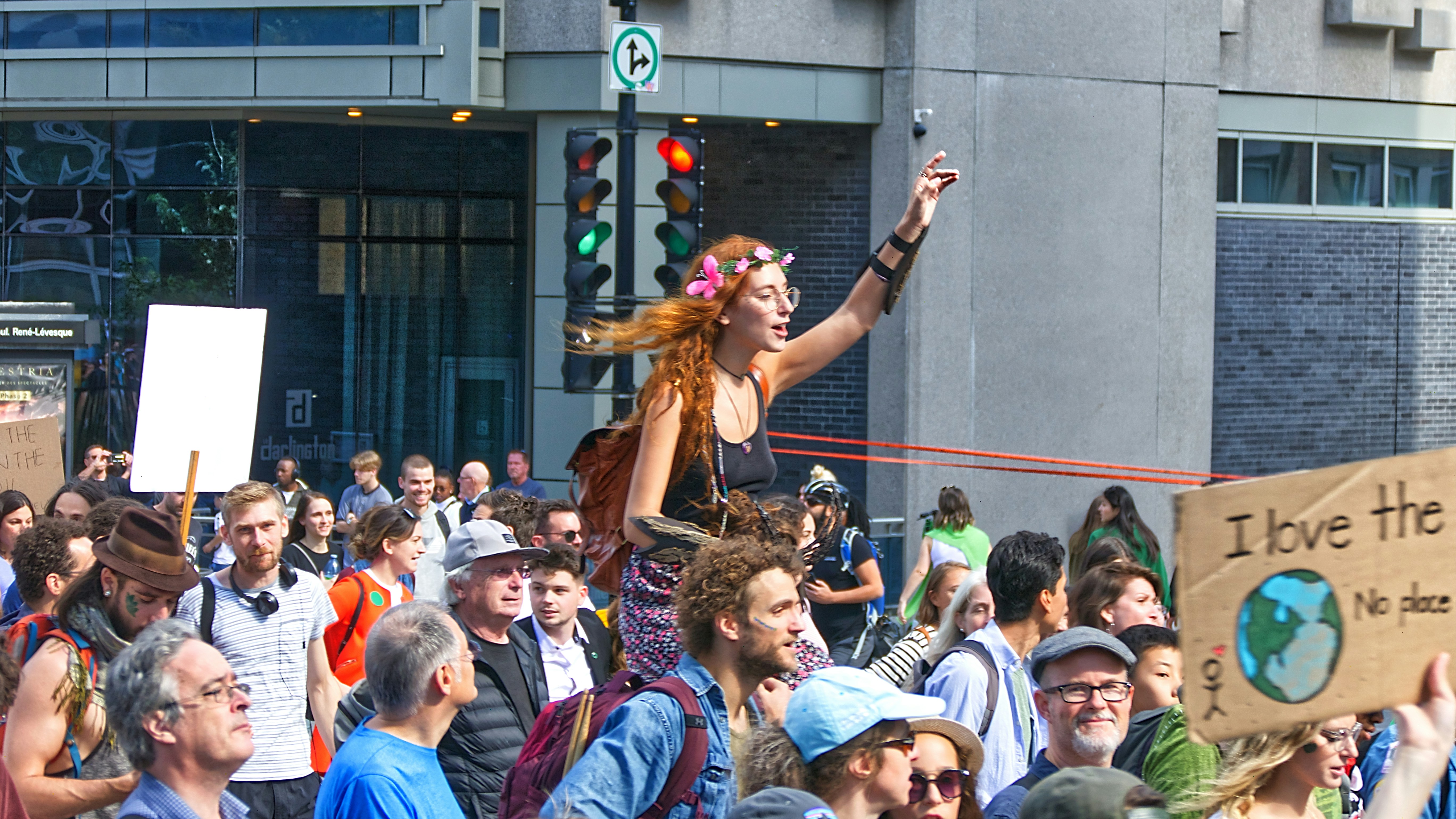 Flower-Crowned Performer Steers the Street Parade Amid a Curious Crowd