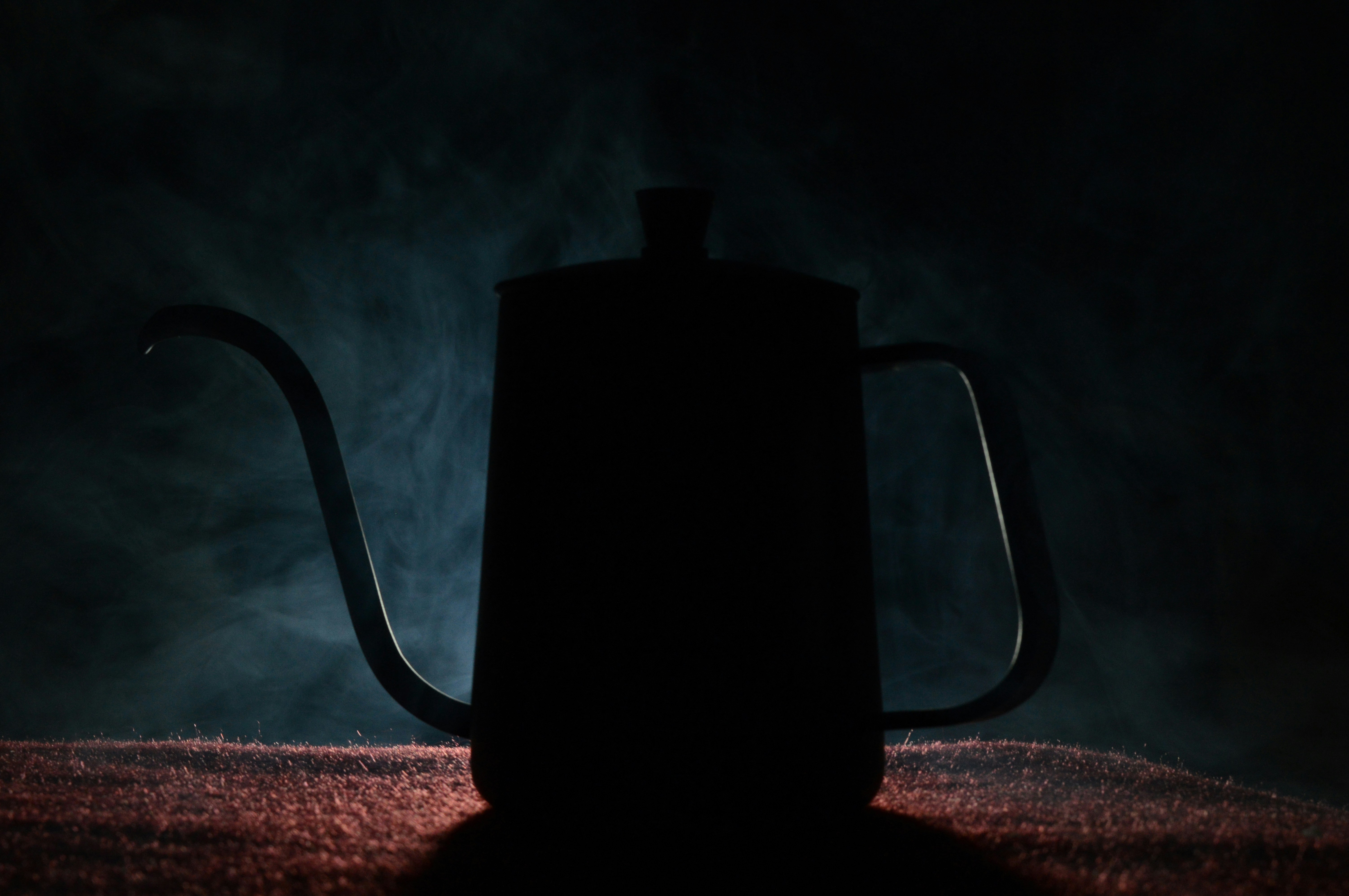 Crimson Table, Veiled Kettle: A Backlit Silhouette with Steam