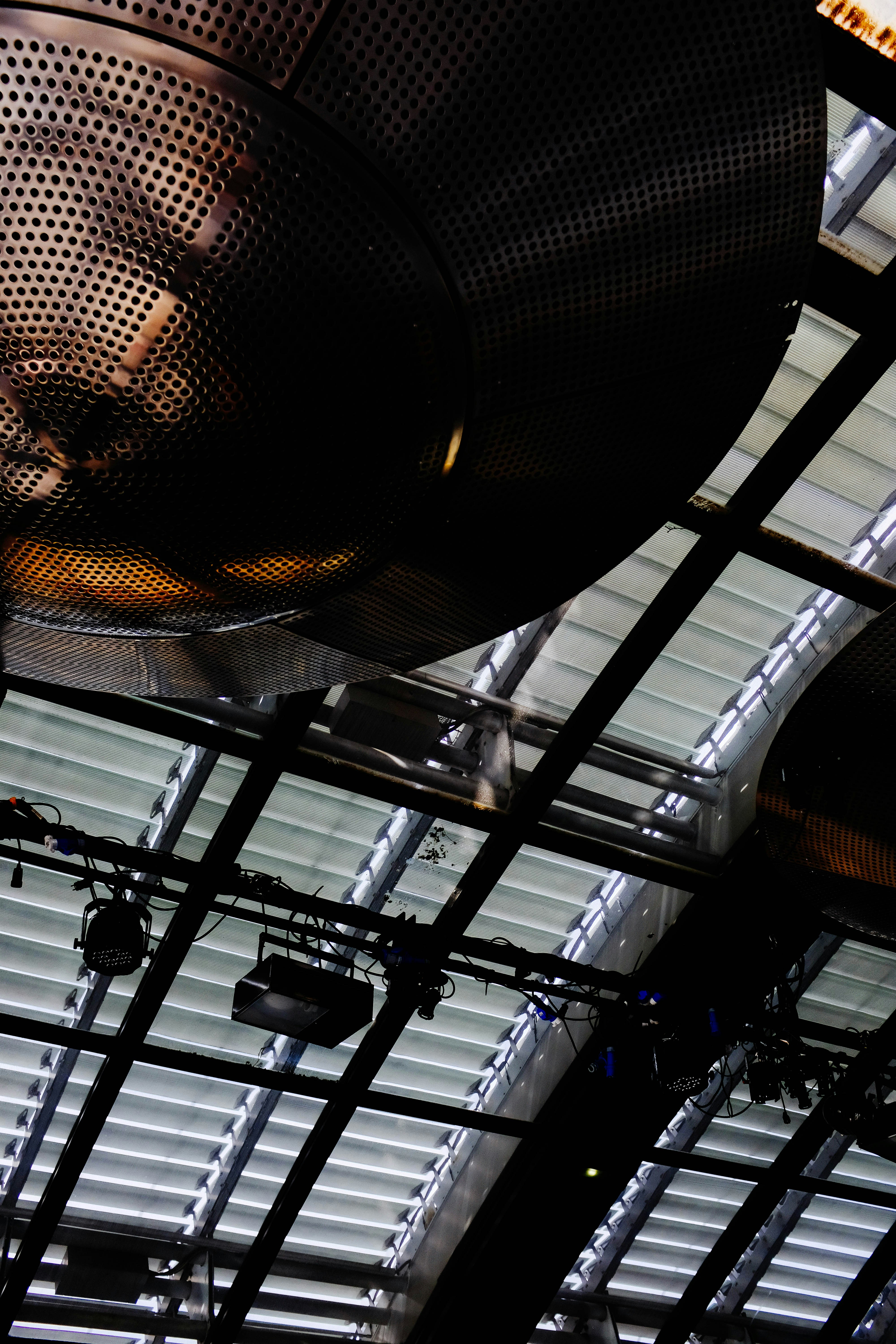 A large fan hanging from the ceiling of a building photo – Free Black ...