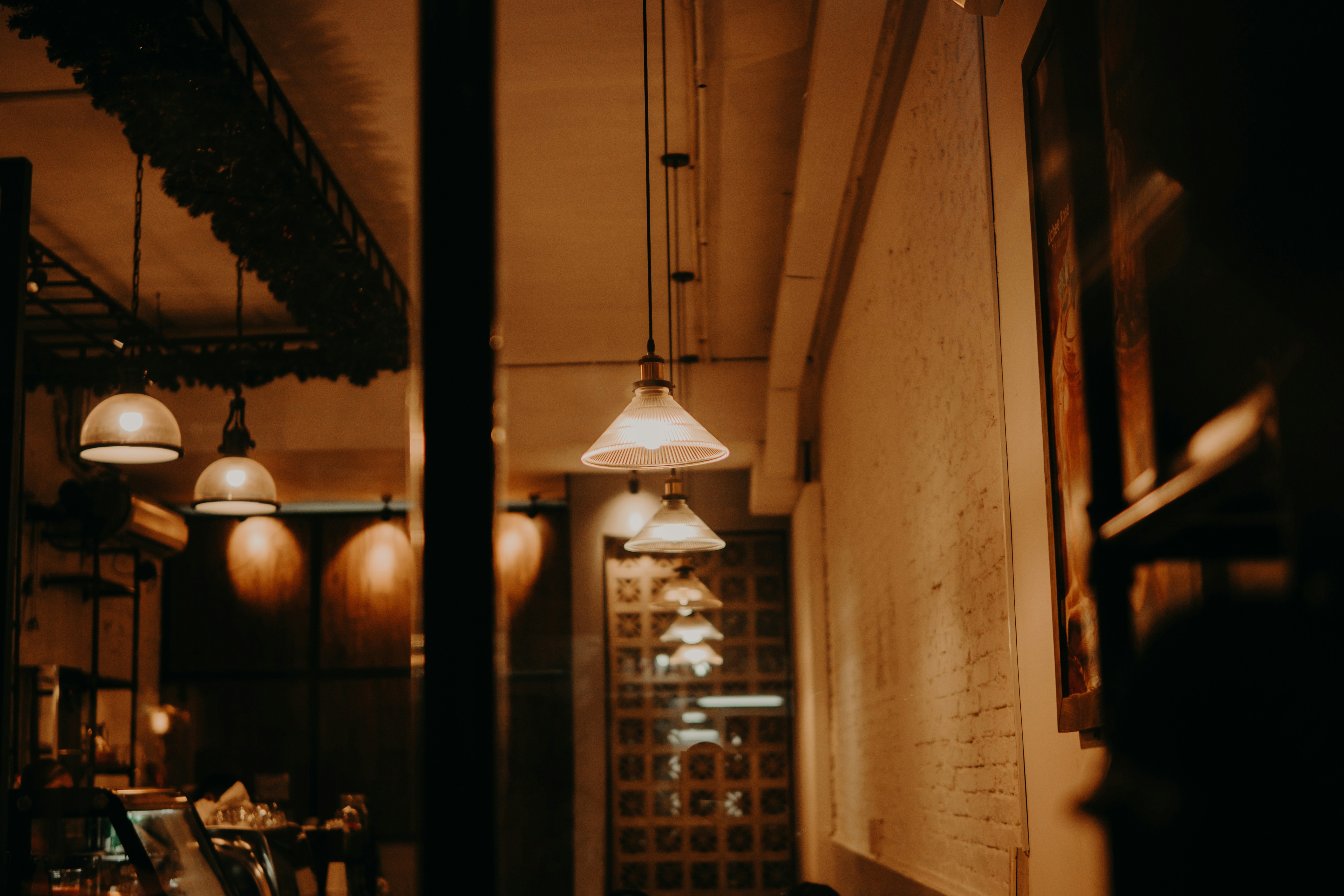 A dimly lit room with several lights hanging from the ceiling photo ...