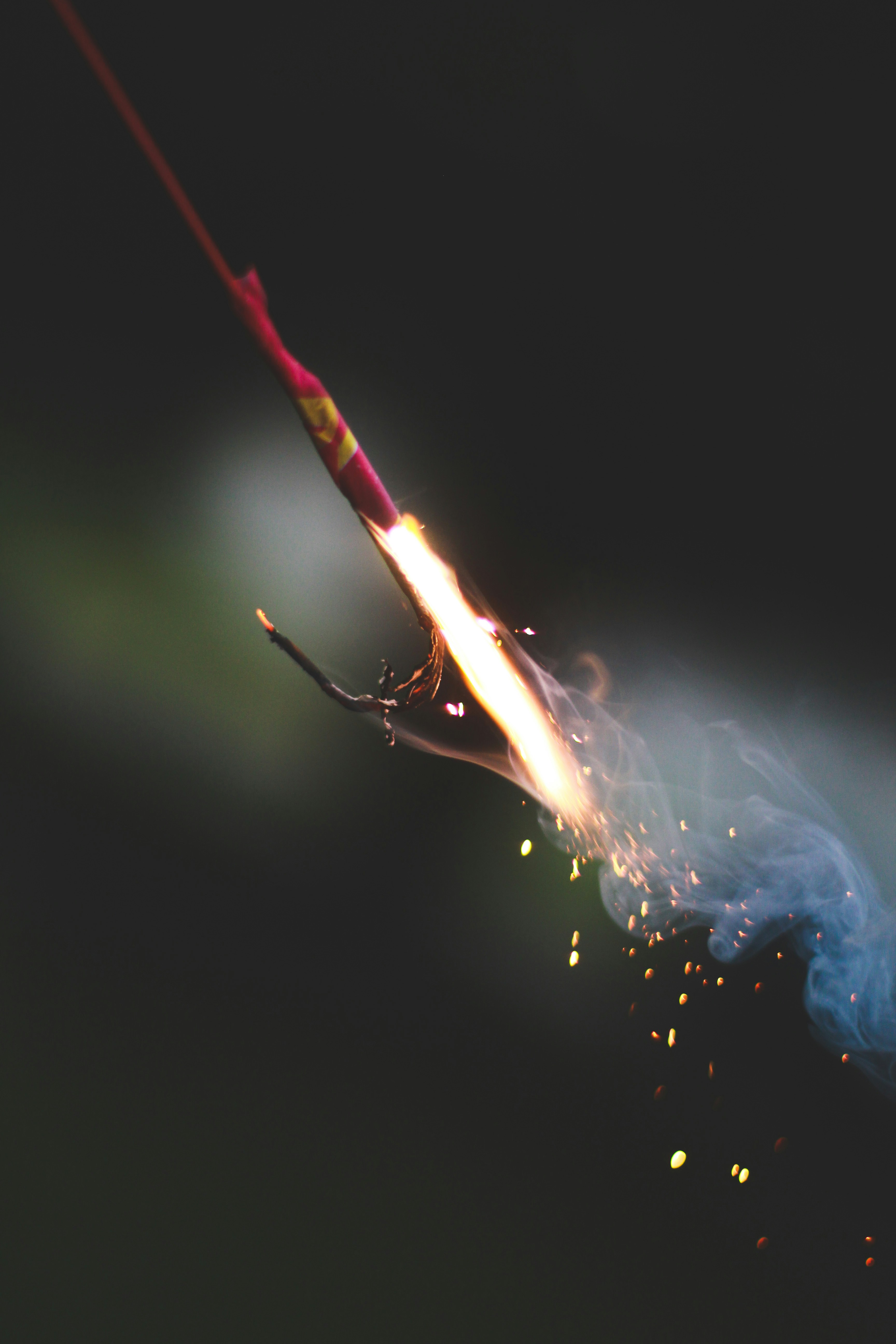Diagonal Spark: ember tracing a fiery line through night