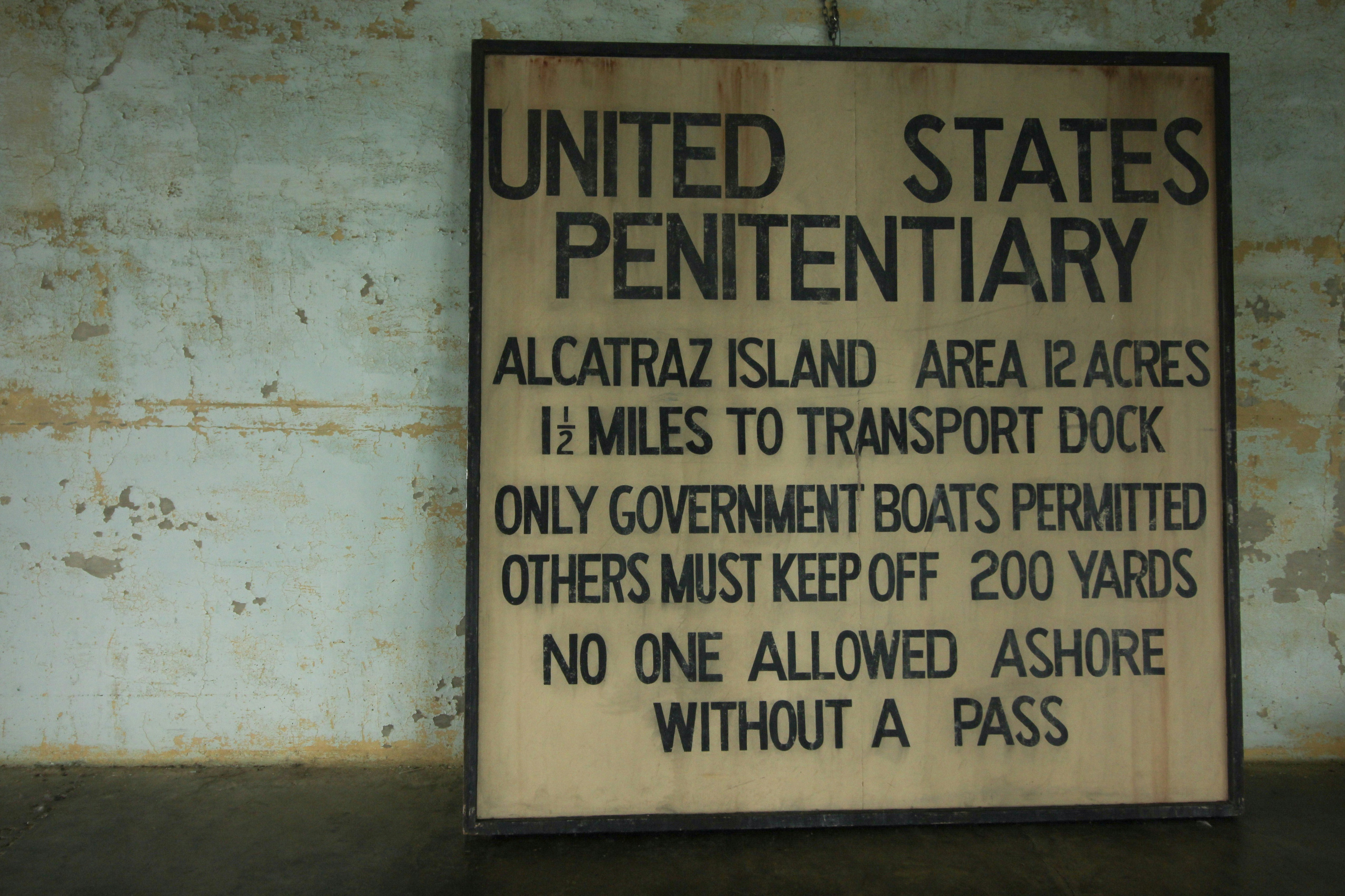 A sign posted on a wall in a building photo – Free Grey Image on Unsplash