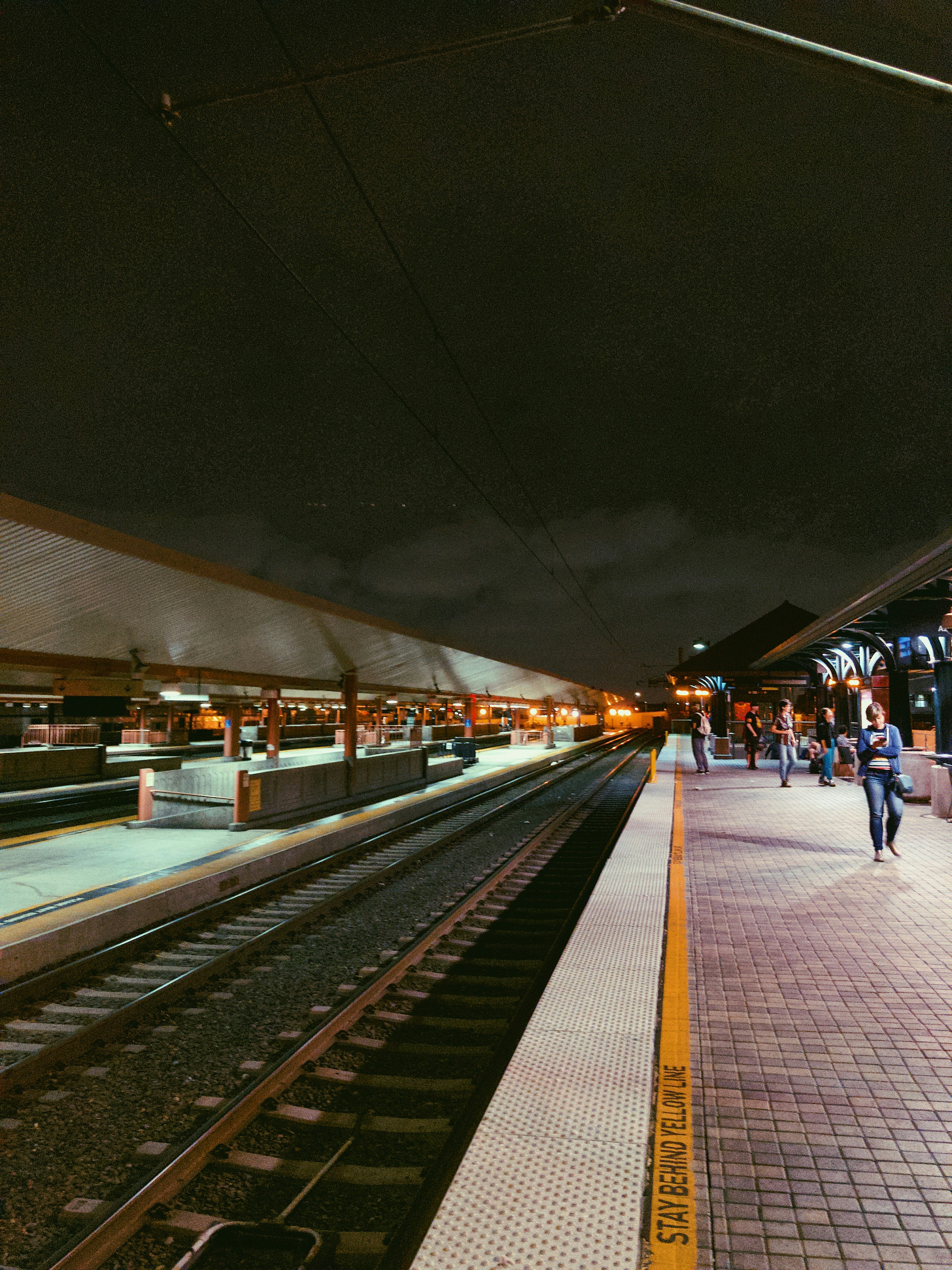 Night Platform Echoes: Warm Lines and Quiet Travelers