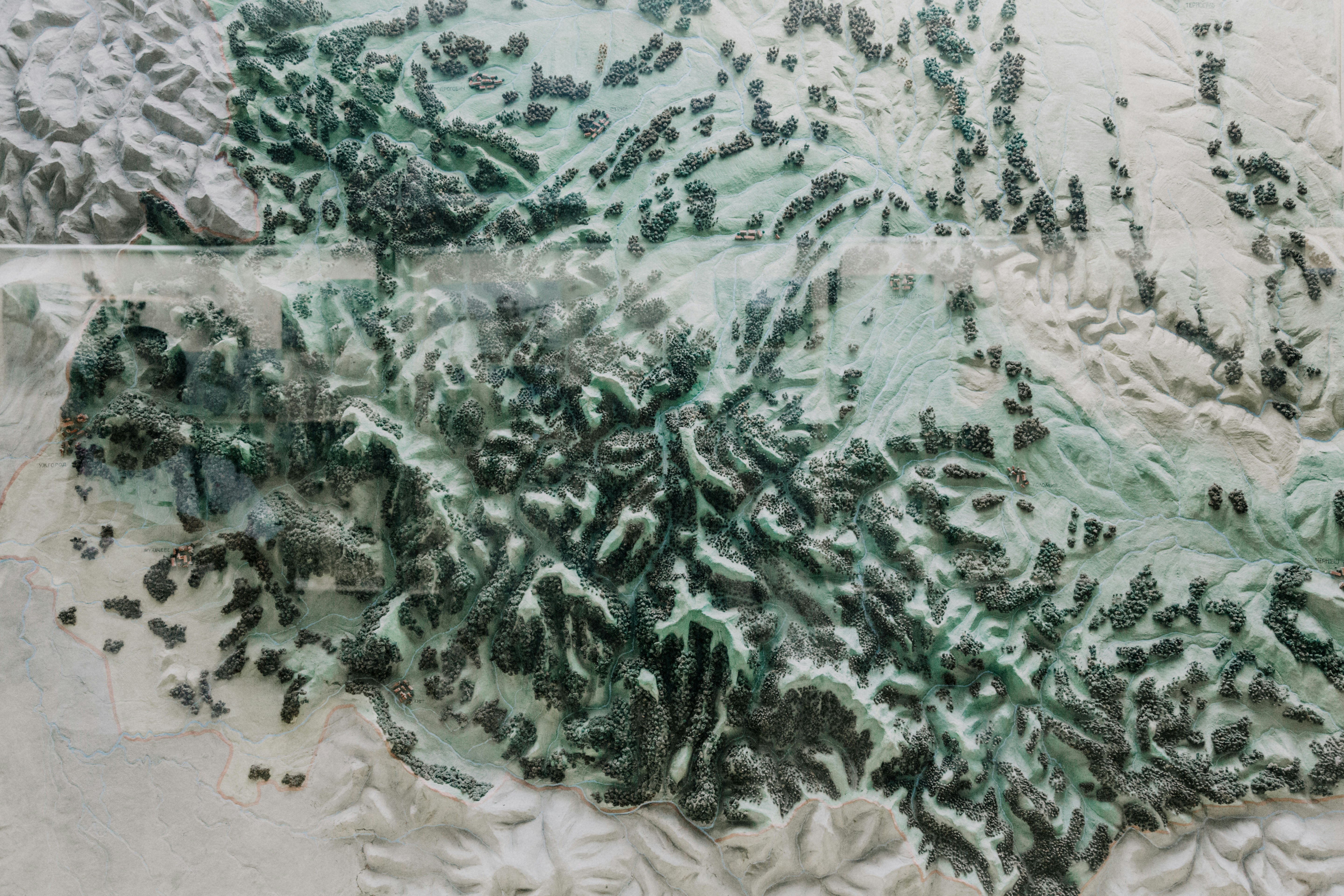Snow-veined ridges weave a shadowed canyon labyrinth from above