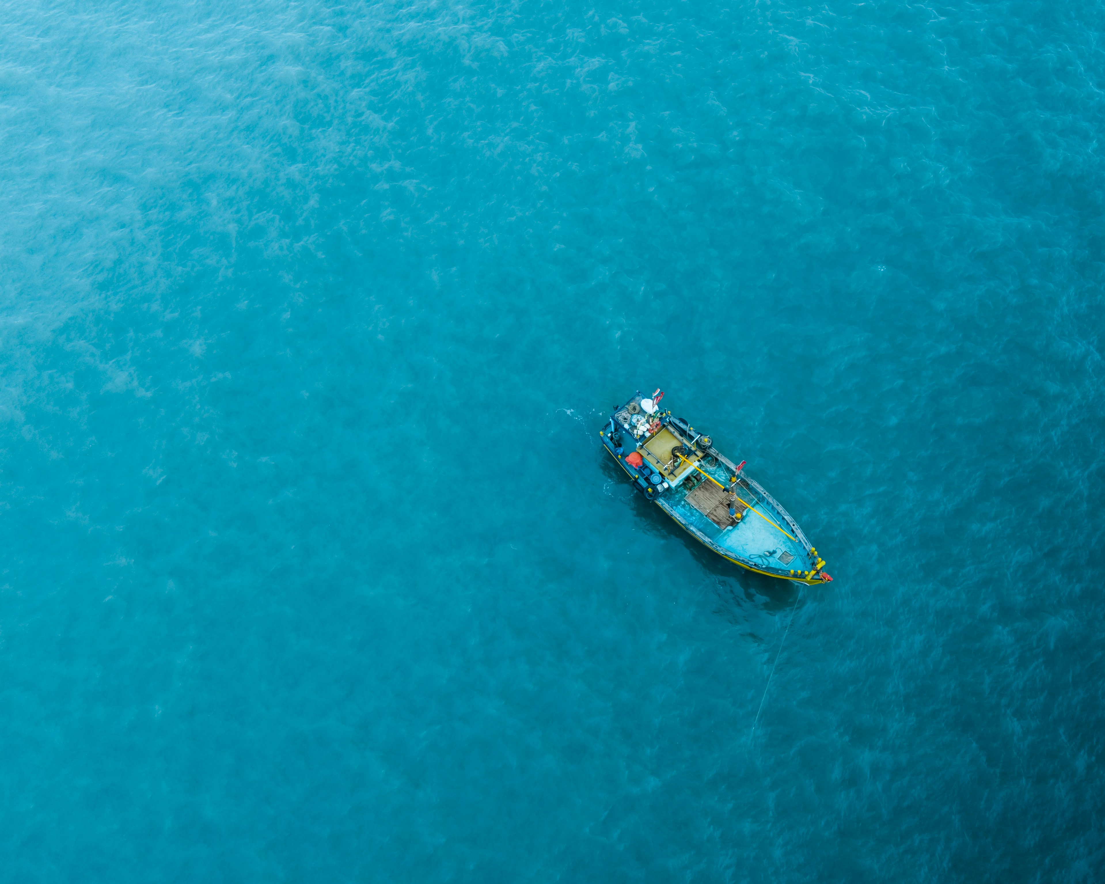 blue canoe boat in the middle of ocean photo – Free Image on Unsplash