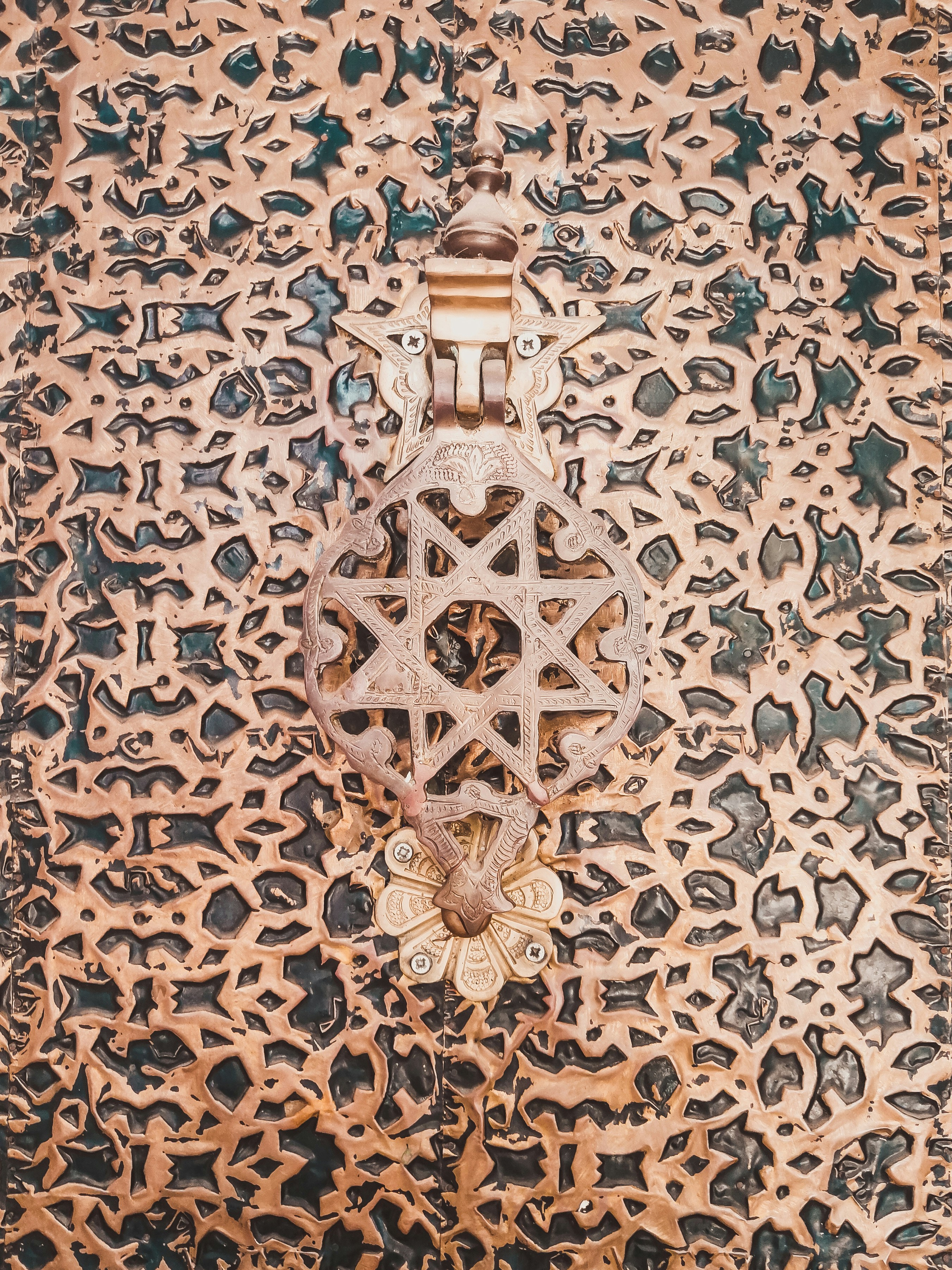 Bronze Star of David pendant on a copper lattice backdrop