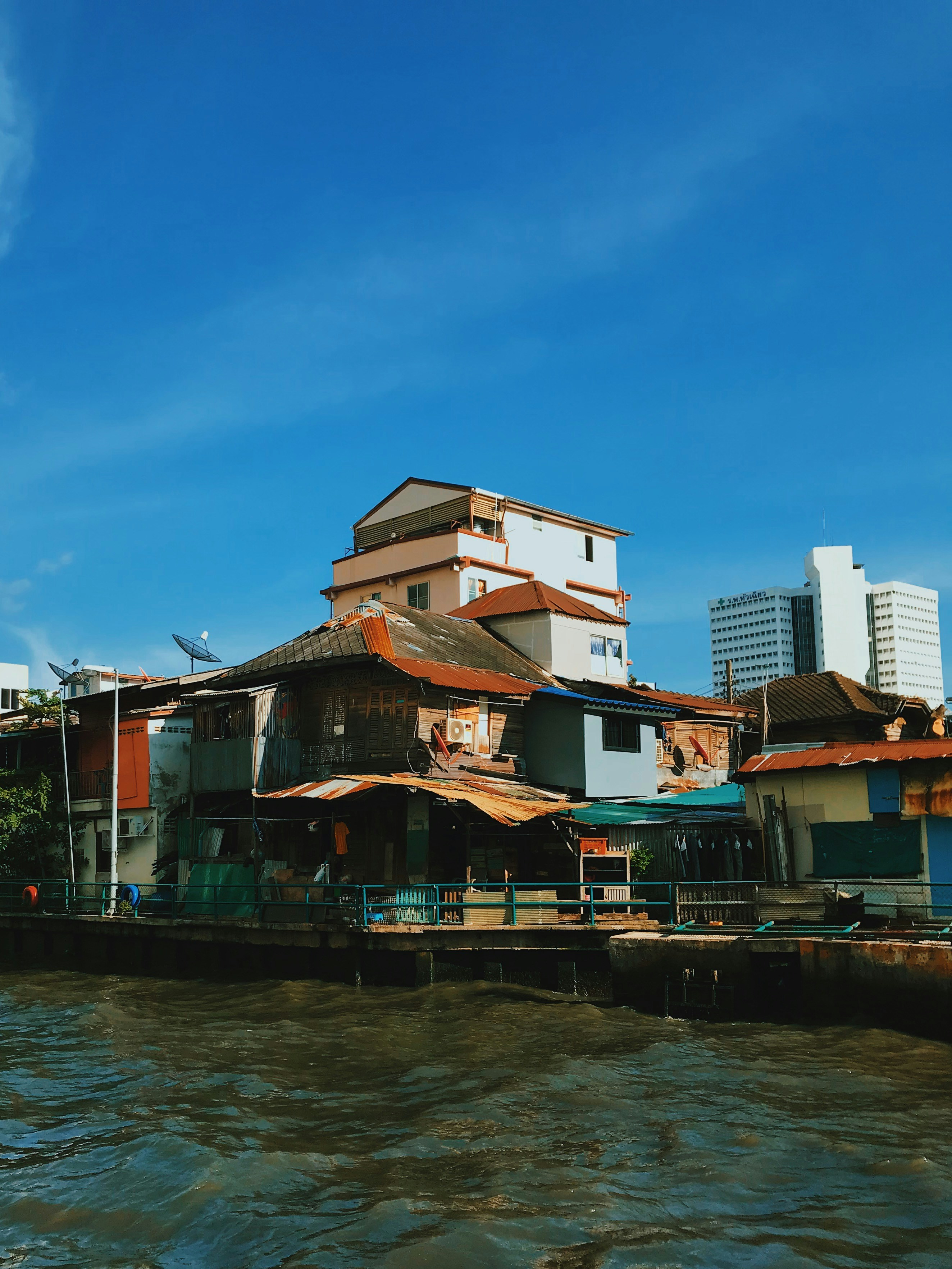 Waterside Shanties under a Bold Urban Sky