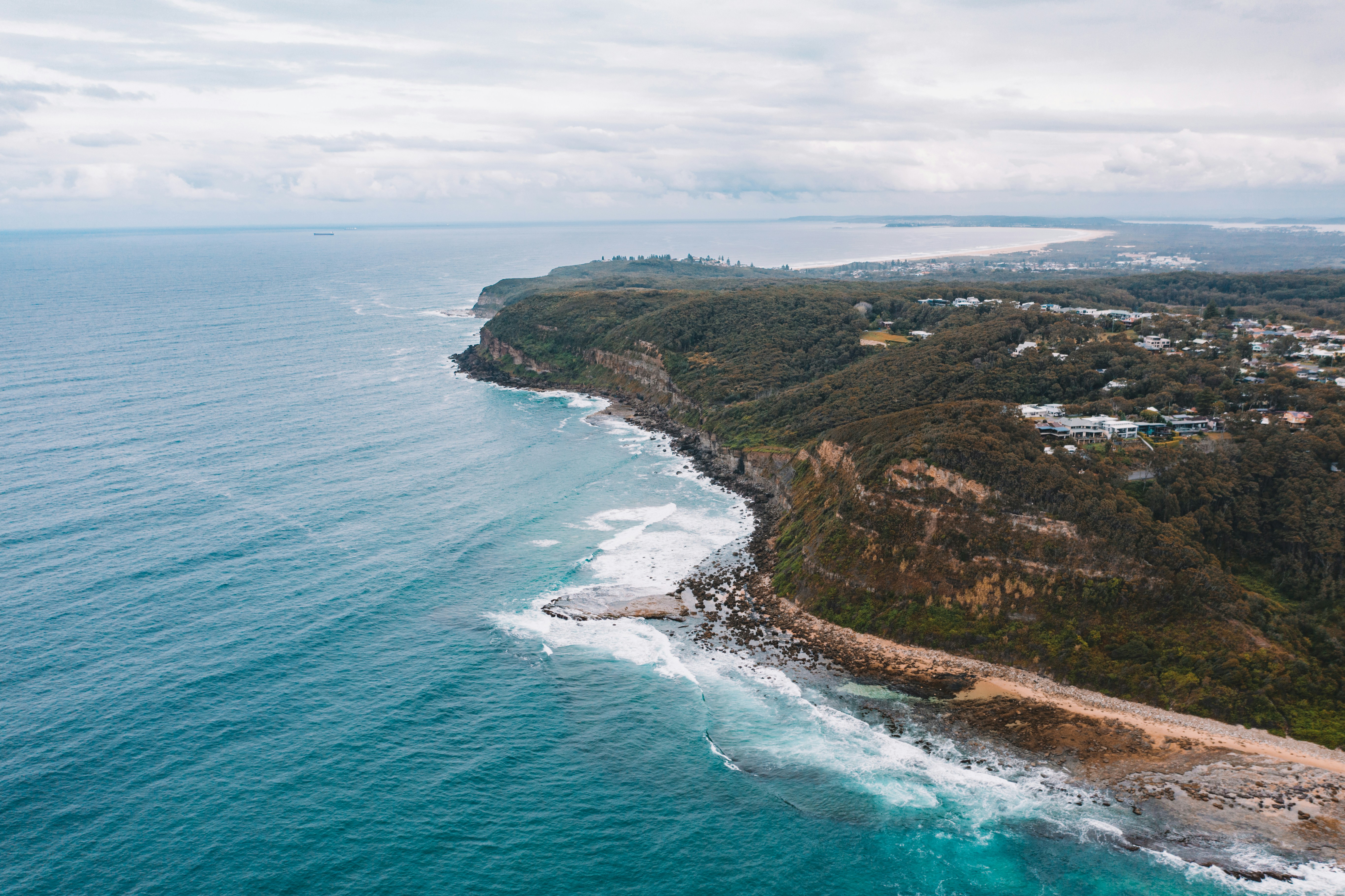 A bird's eye view of the ocean and coastline photo – Free Grey Image on ...