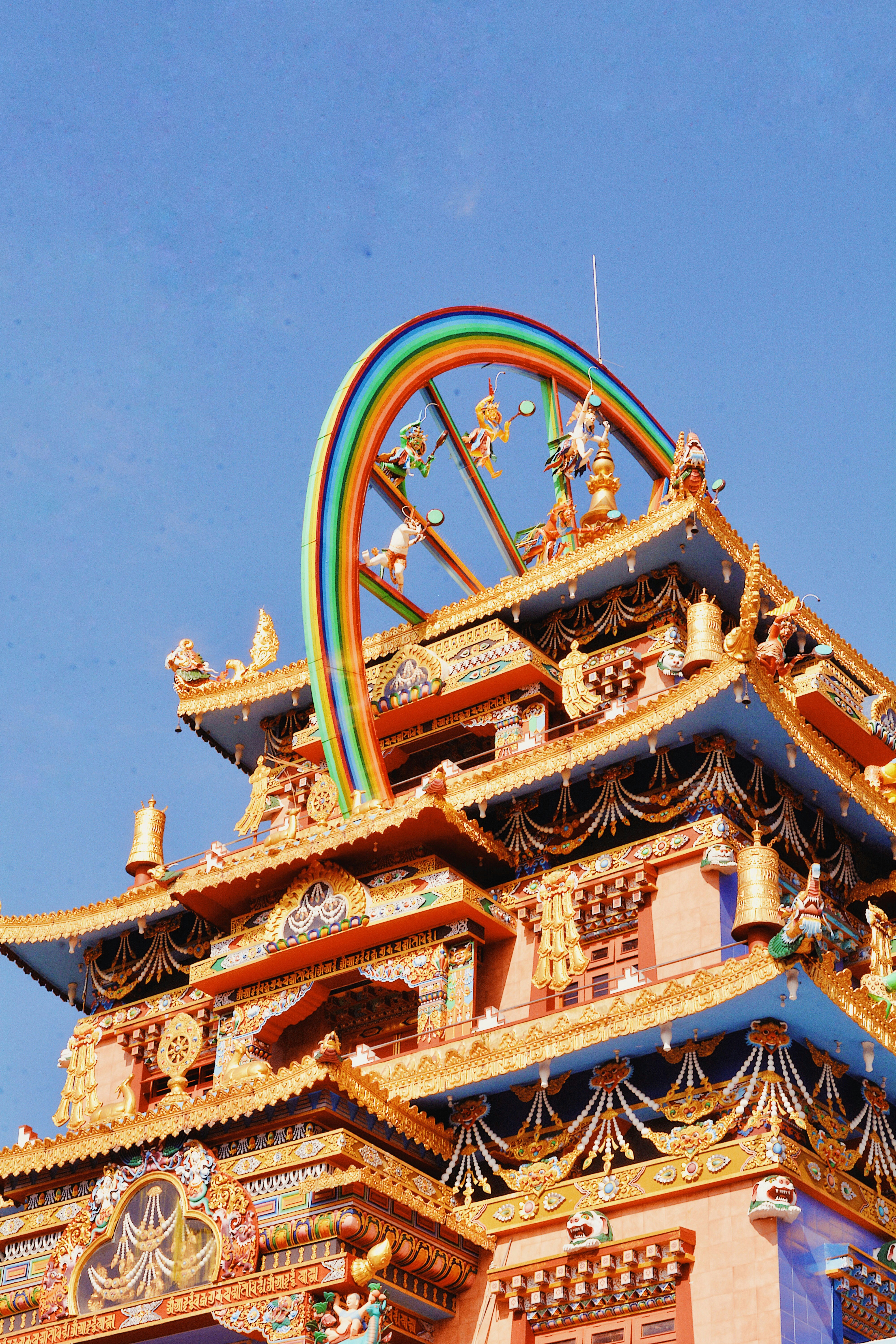 Rainbow Arch Over a Gilded Chinese Temple Rooftop
