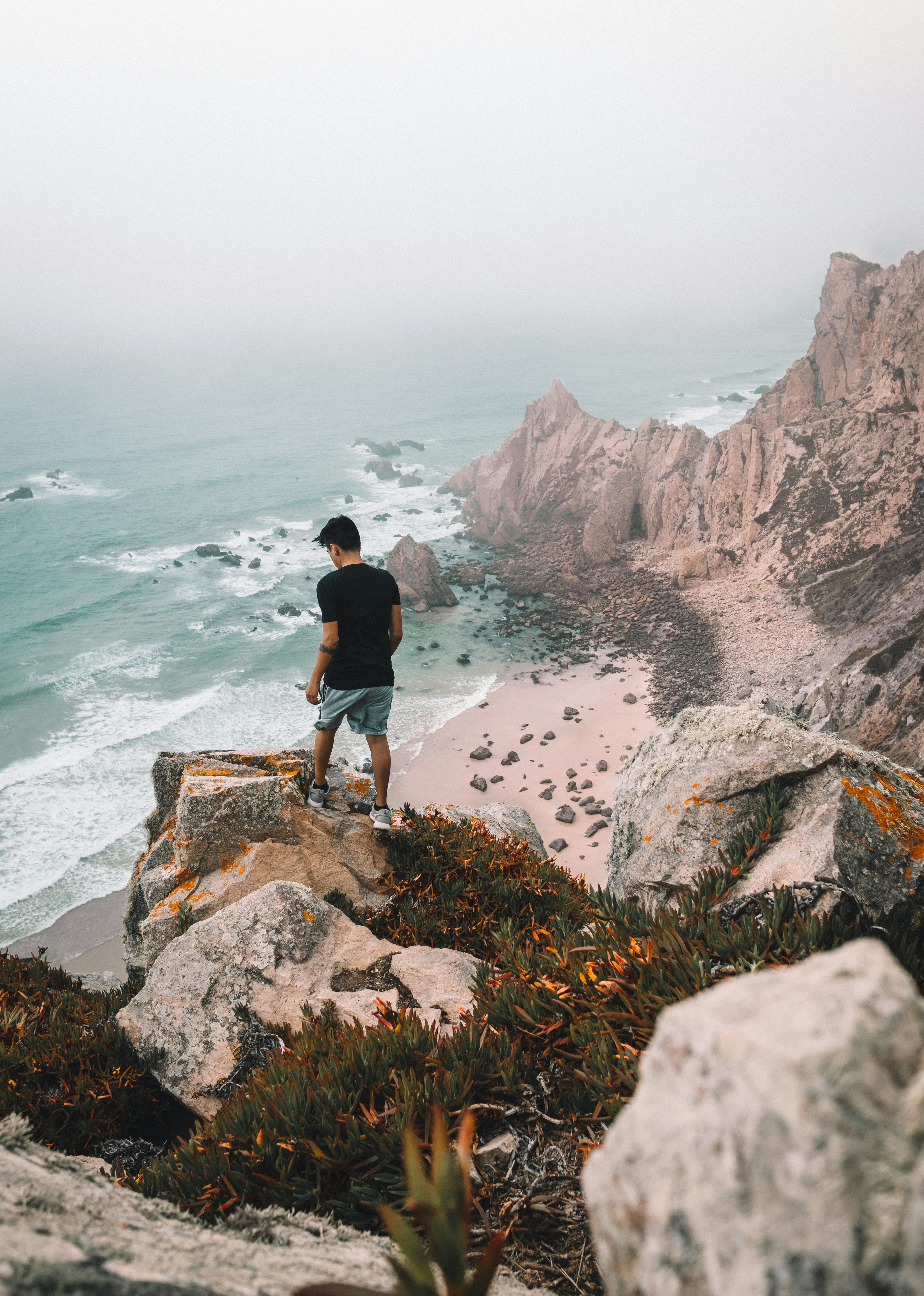 Edgebound in Mist: A Solo Figure on the Cliff's Edge