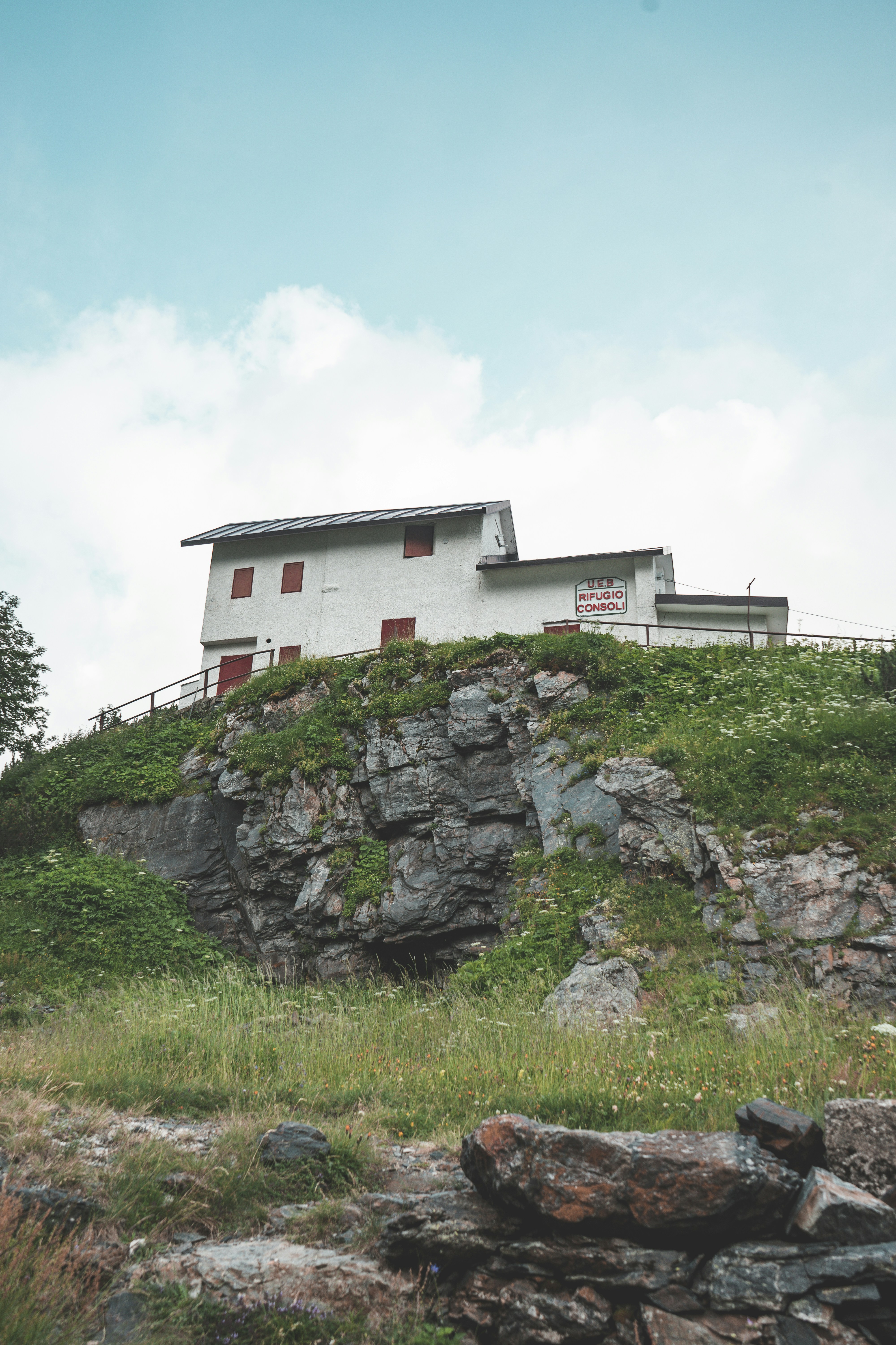 White Refuge on a Craggy Crest Under a Quiet Sky