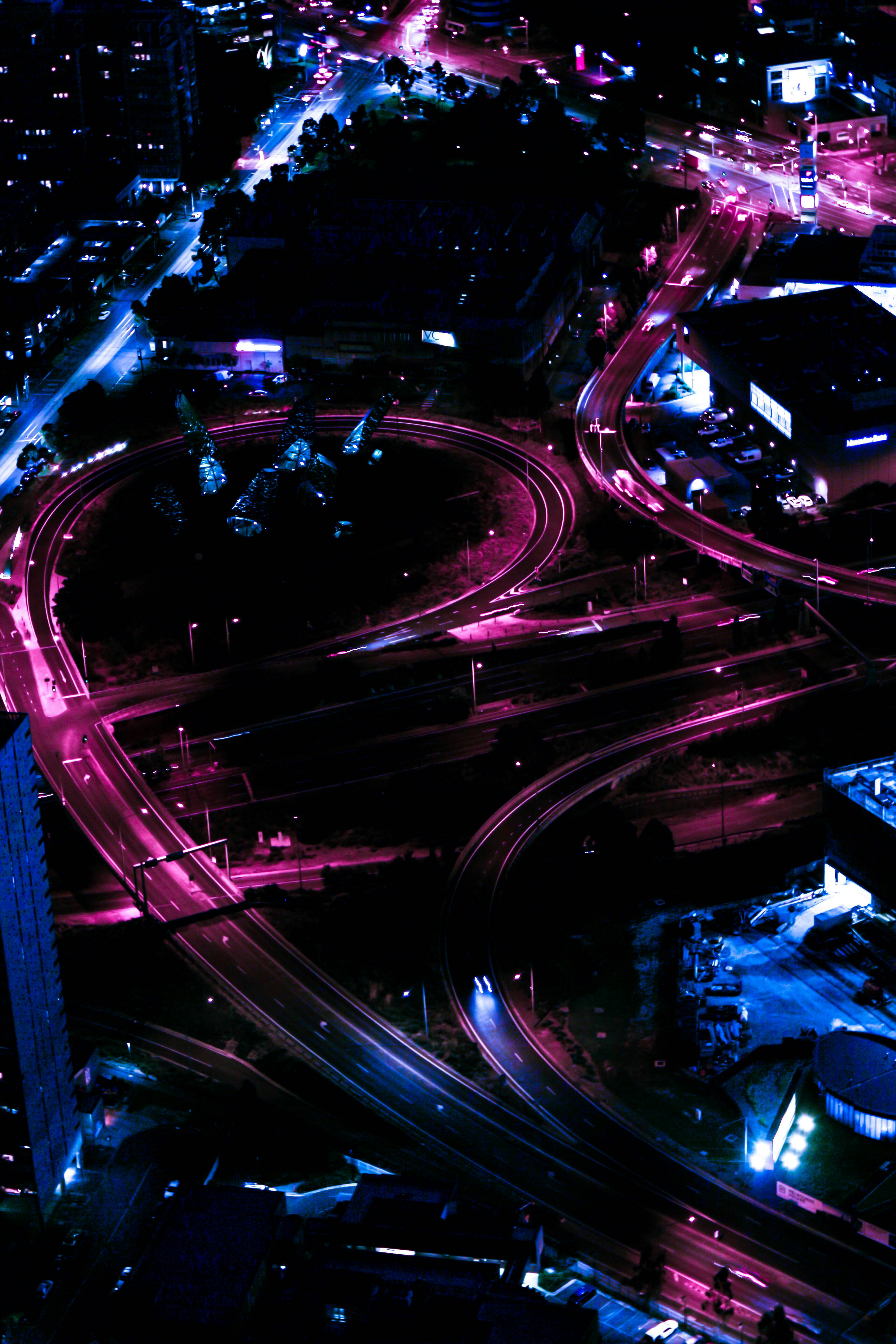 Neon Ribbons at the Roundabout: Aerial Nightscape in Magenta and Blue