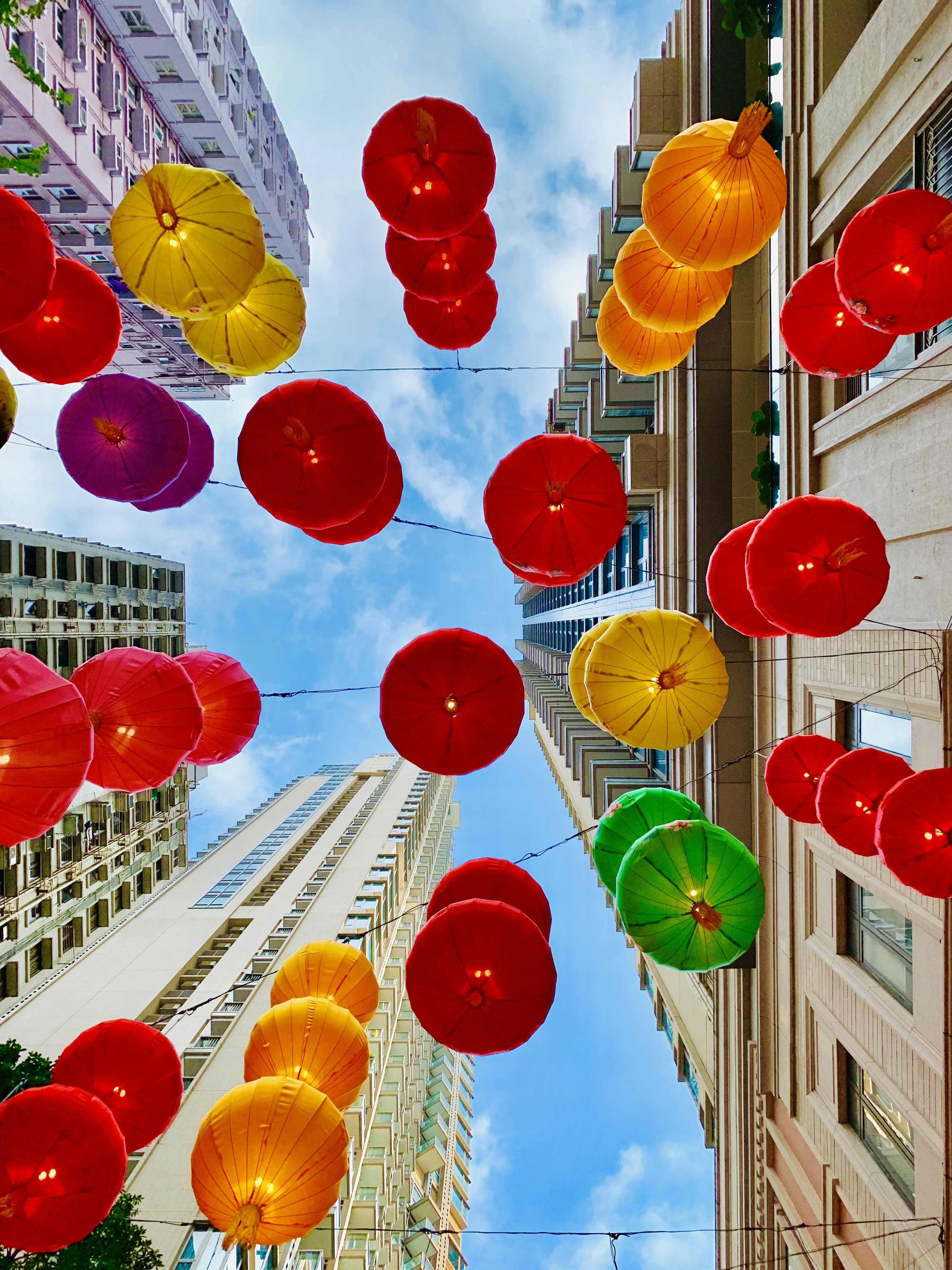 Skybound Lanterns Over an Urban Canyon