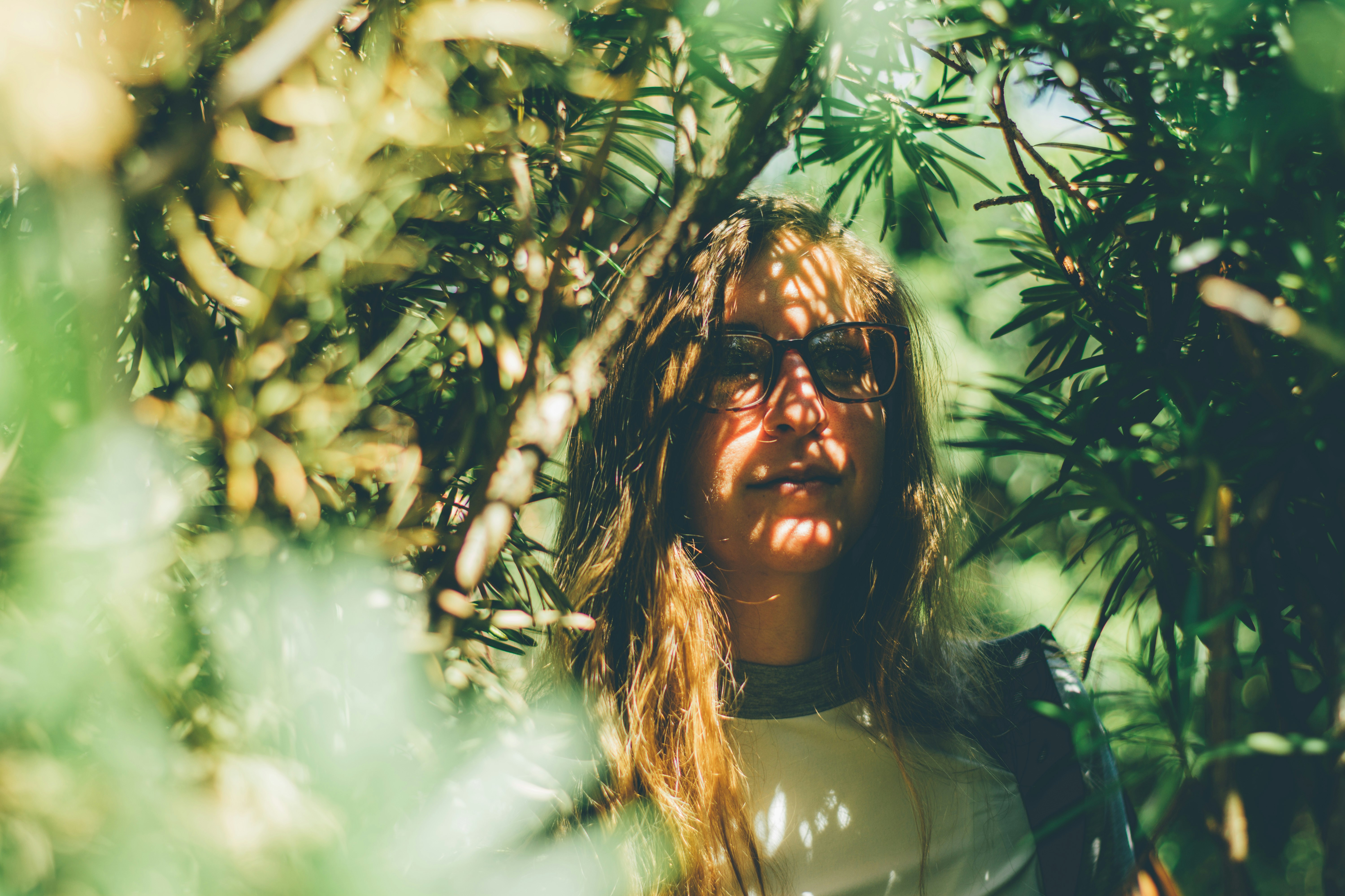 Woman standing between trees at daytime photo – Free Tree Image on Unsplash