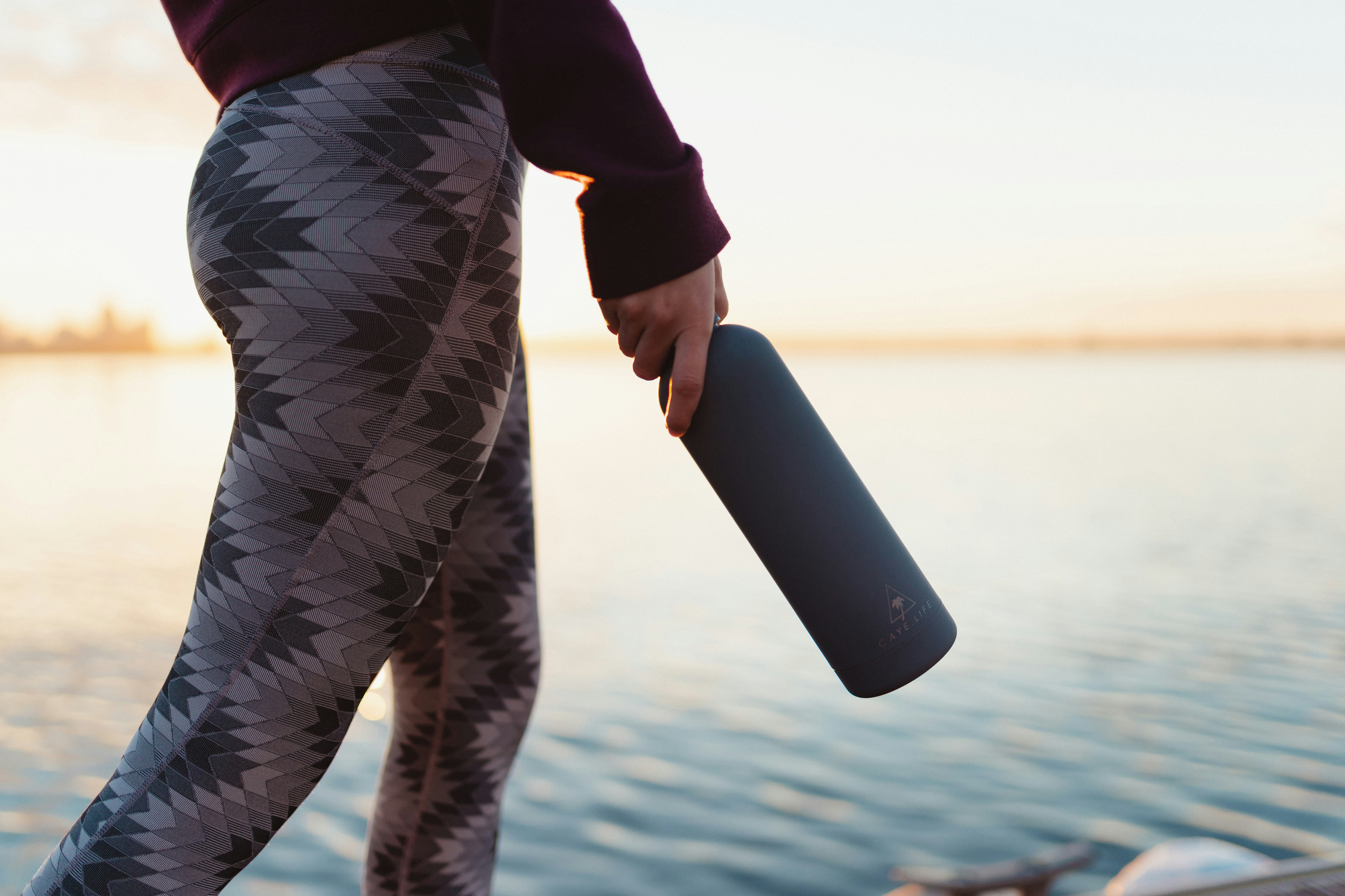 A person standing on a dock with a water bottle photo – Free Fashion ...