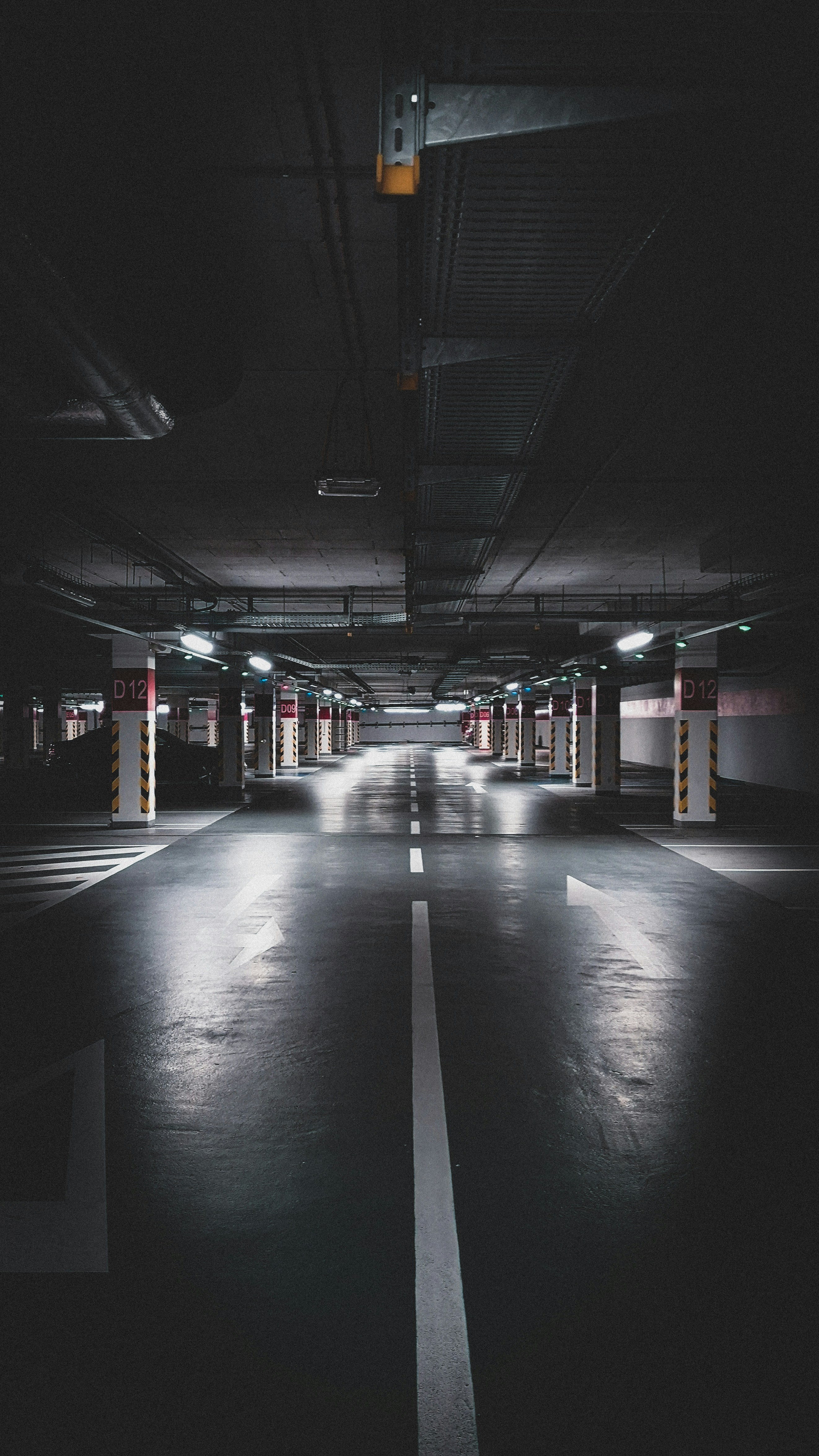 An empty parking garage at night with lights on photo – Free Car Image ...