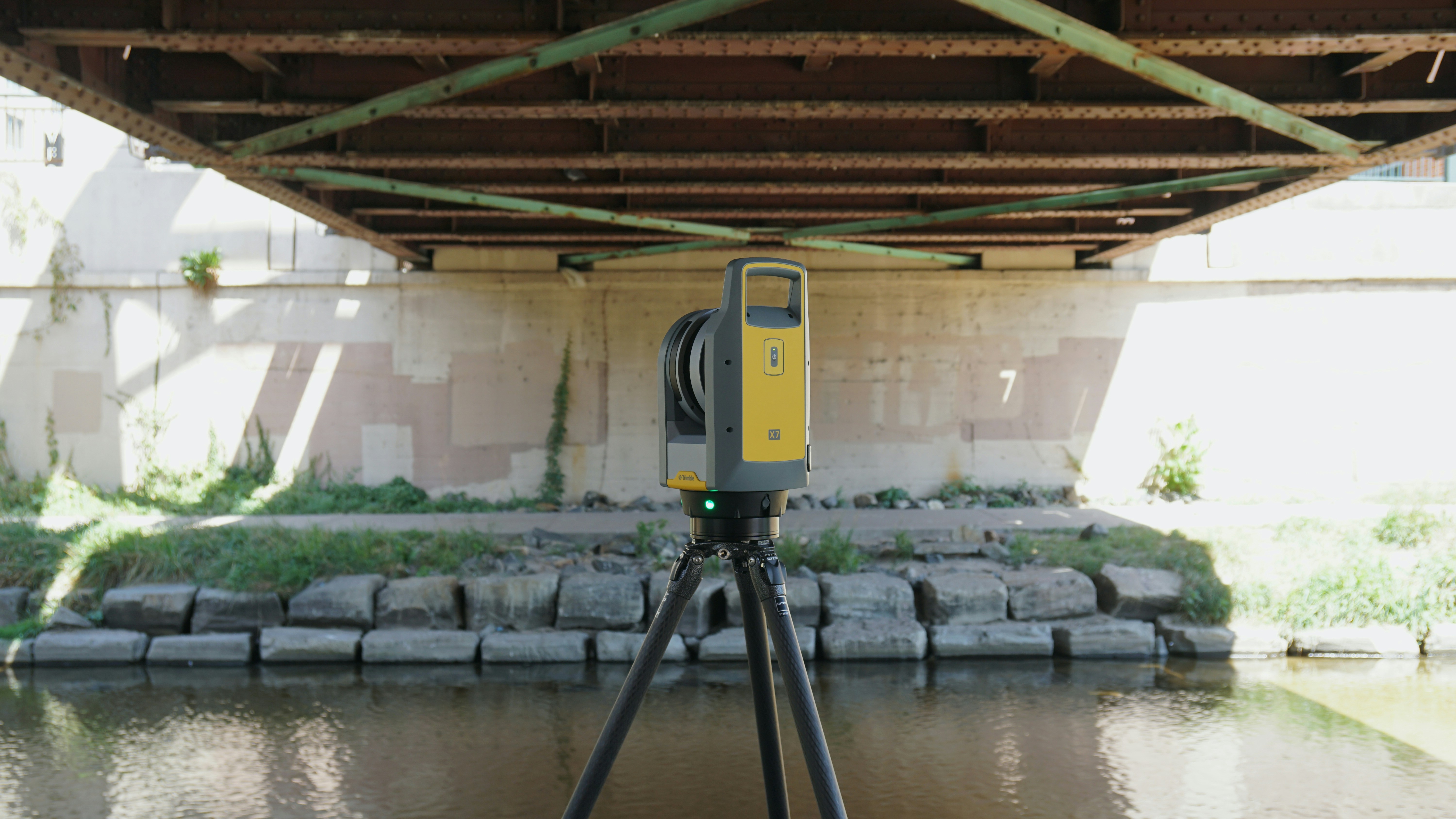 A camera on a tripod in front of a body of water photo – Free Trimble ...