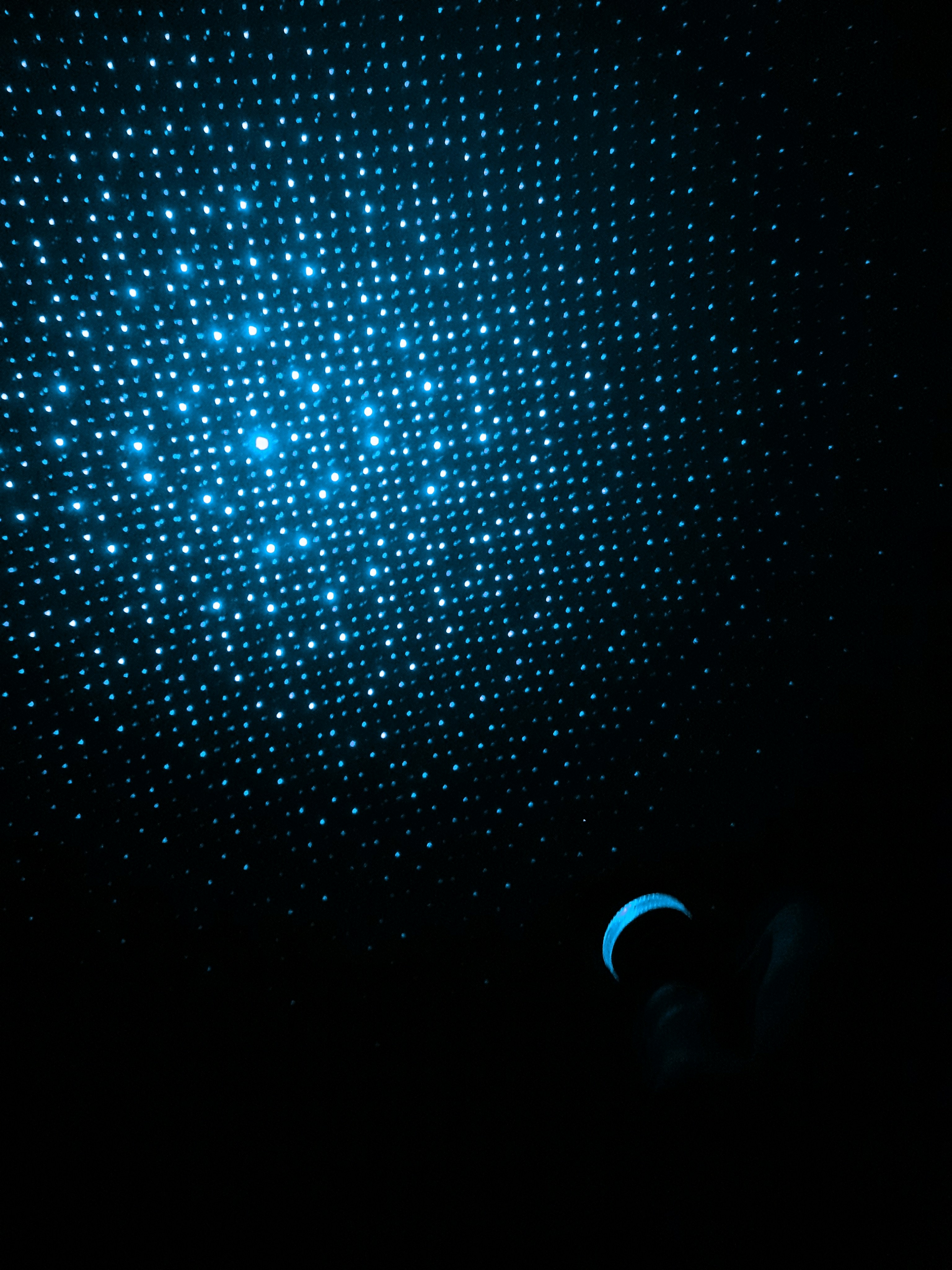 Pattern of blue dots forming a radiant grid against a dark background.