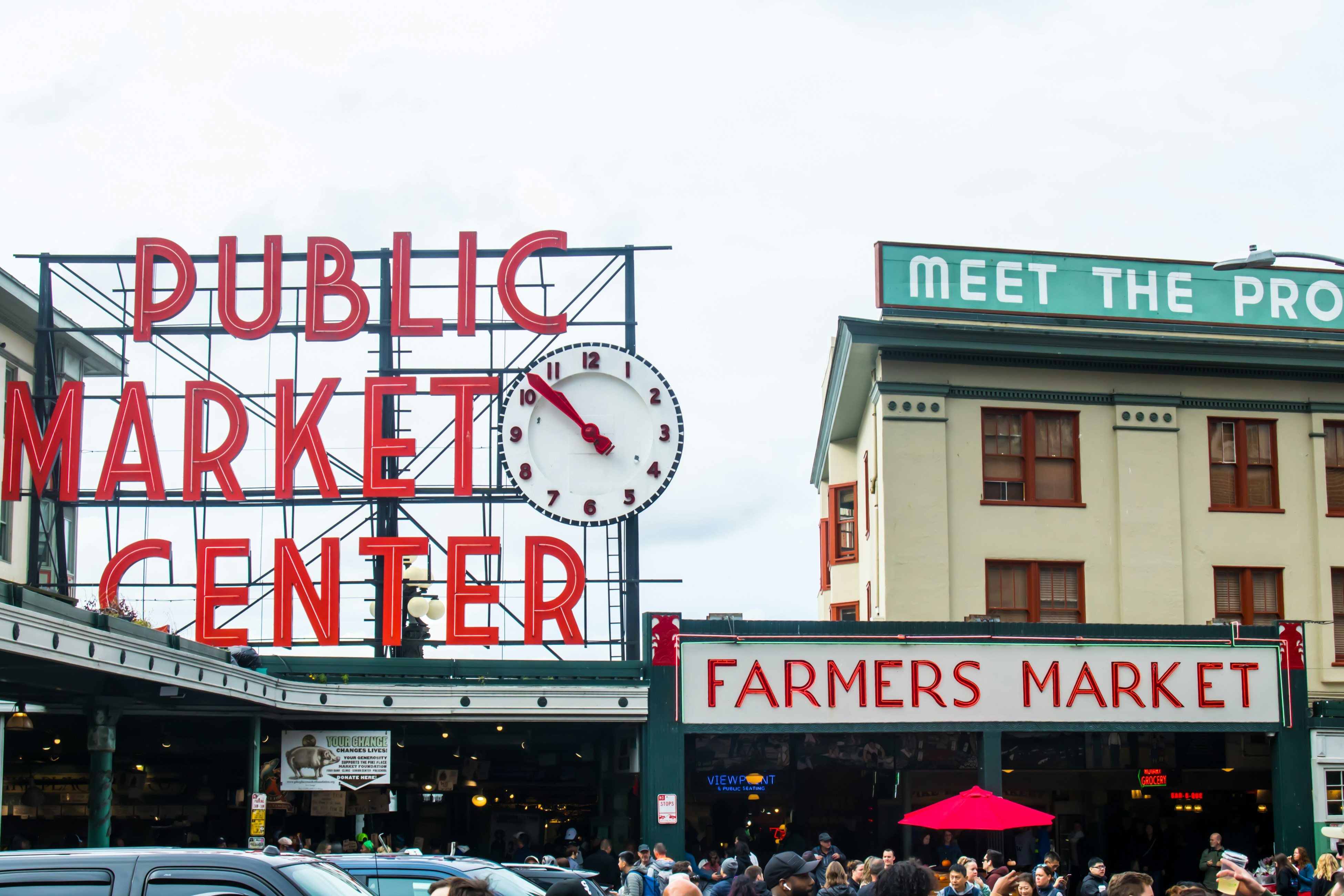 Pike Place Market’s Public Market Center: Neon Sign, Clock, and a Crowded Entrance