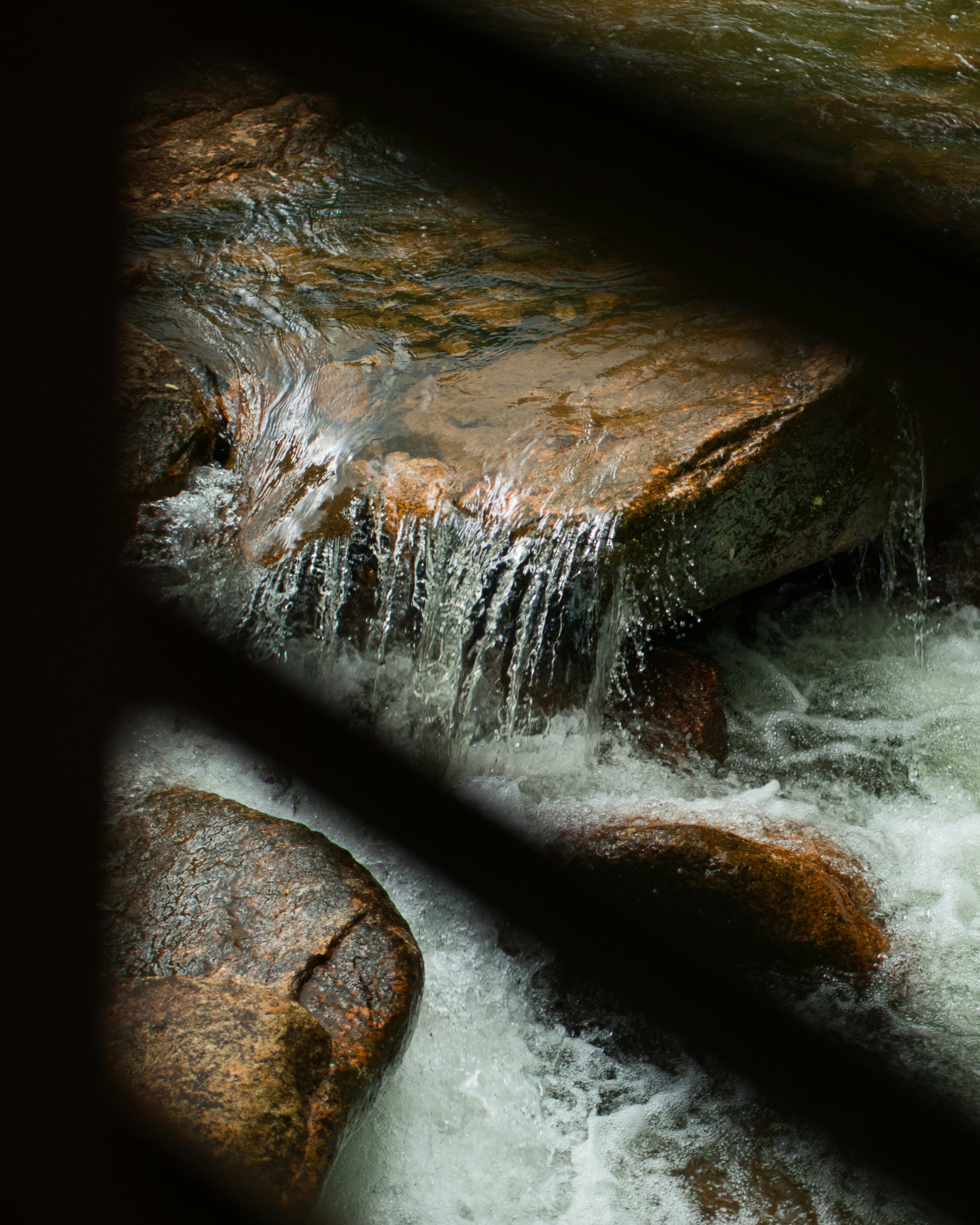 Hidden Cascades Behind Darkened Railings