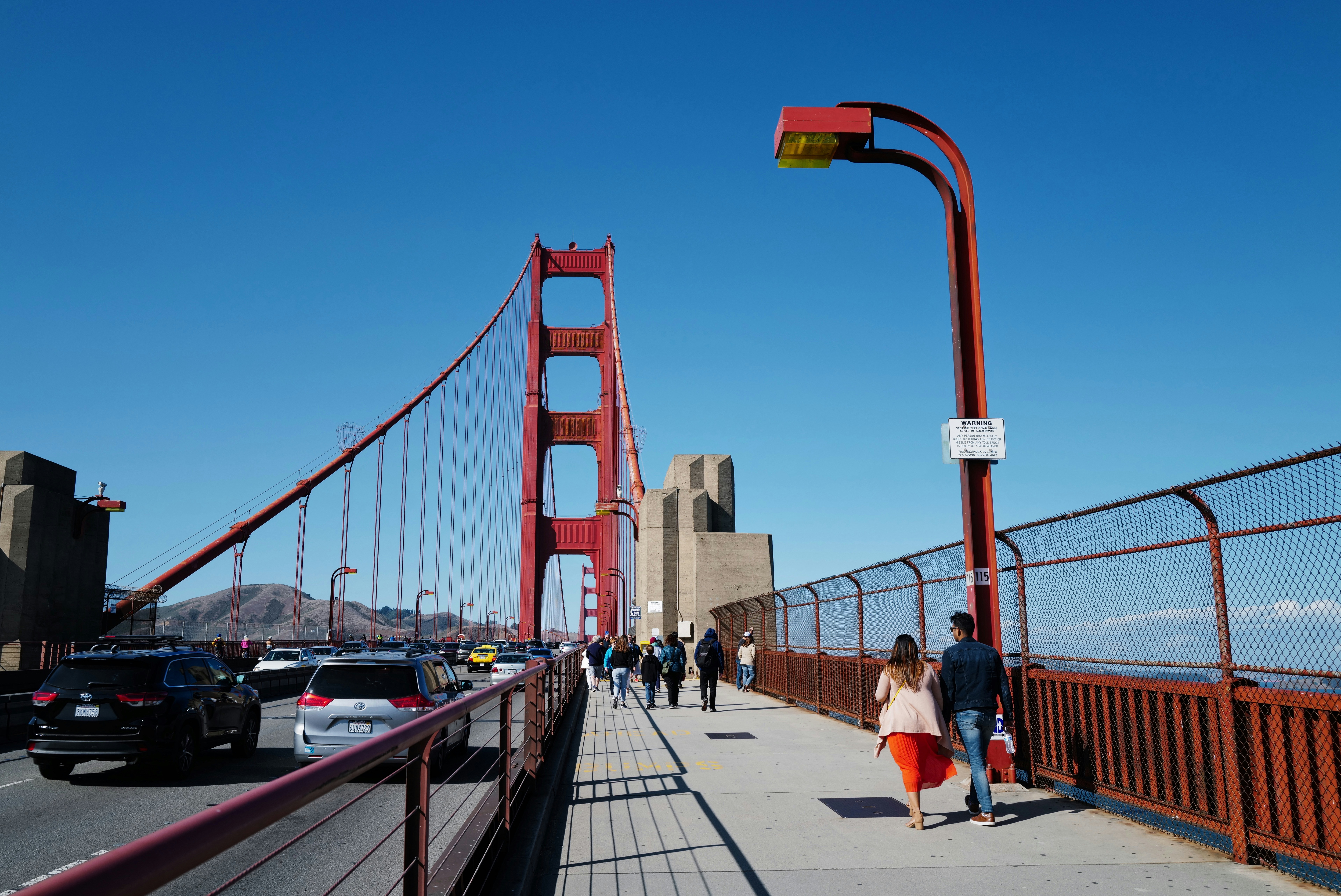 people and vehicles on golden gate bridge
