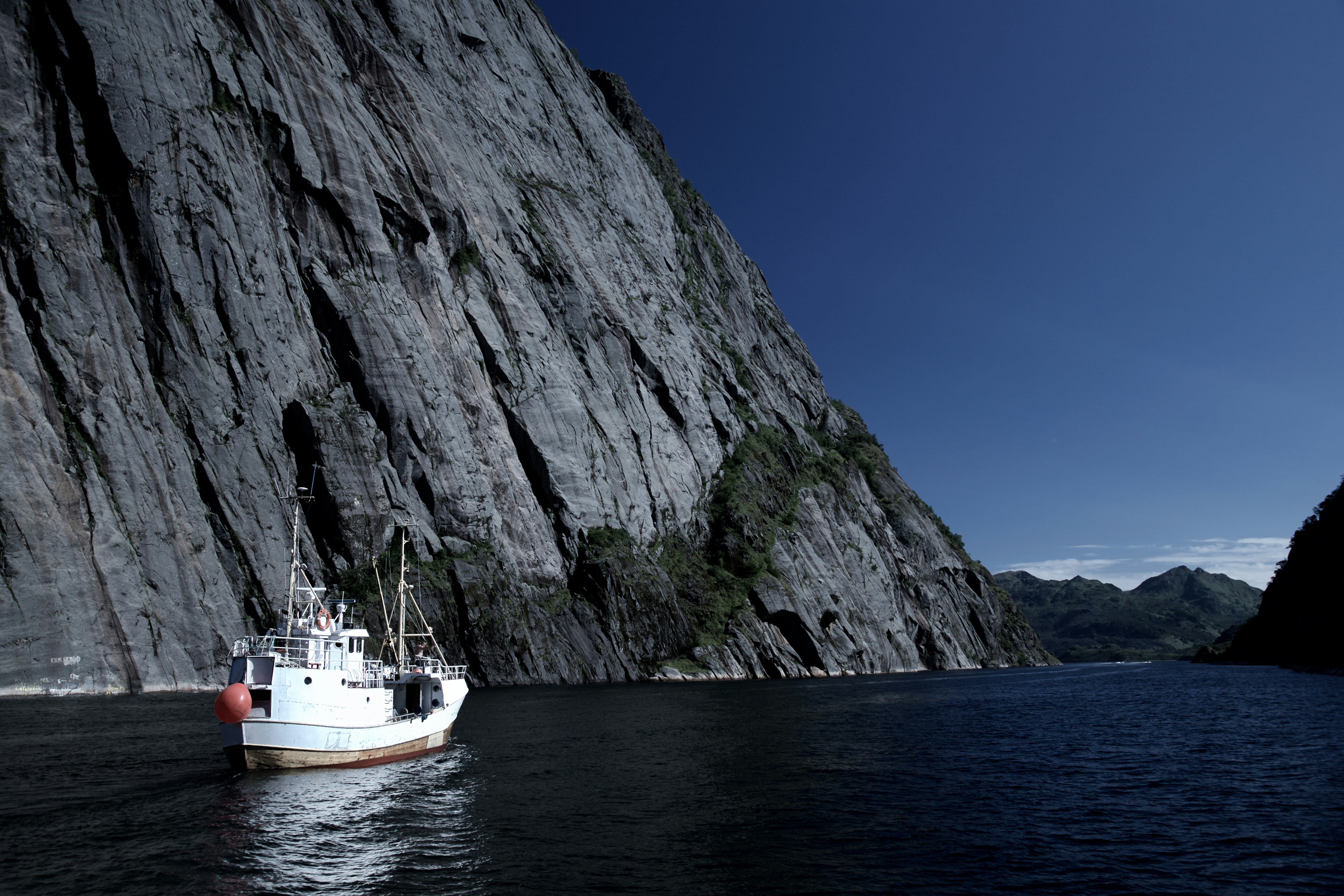 White boat on body of water beside gray cliff photo – Free Austvågøy ...