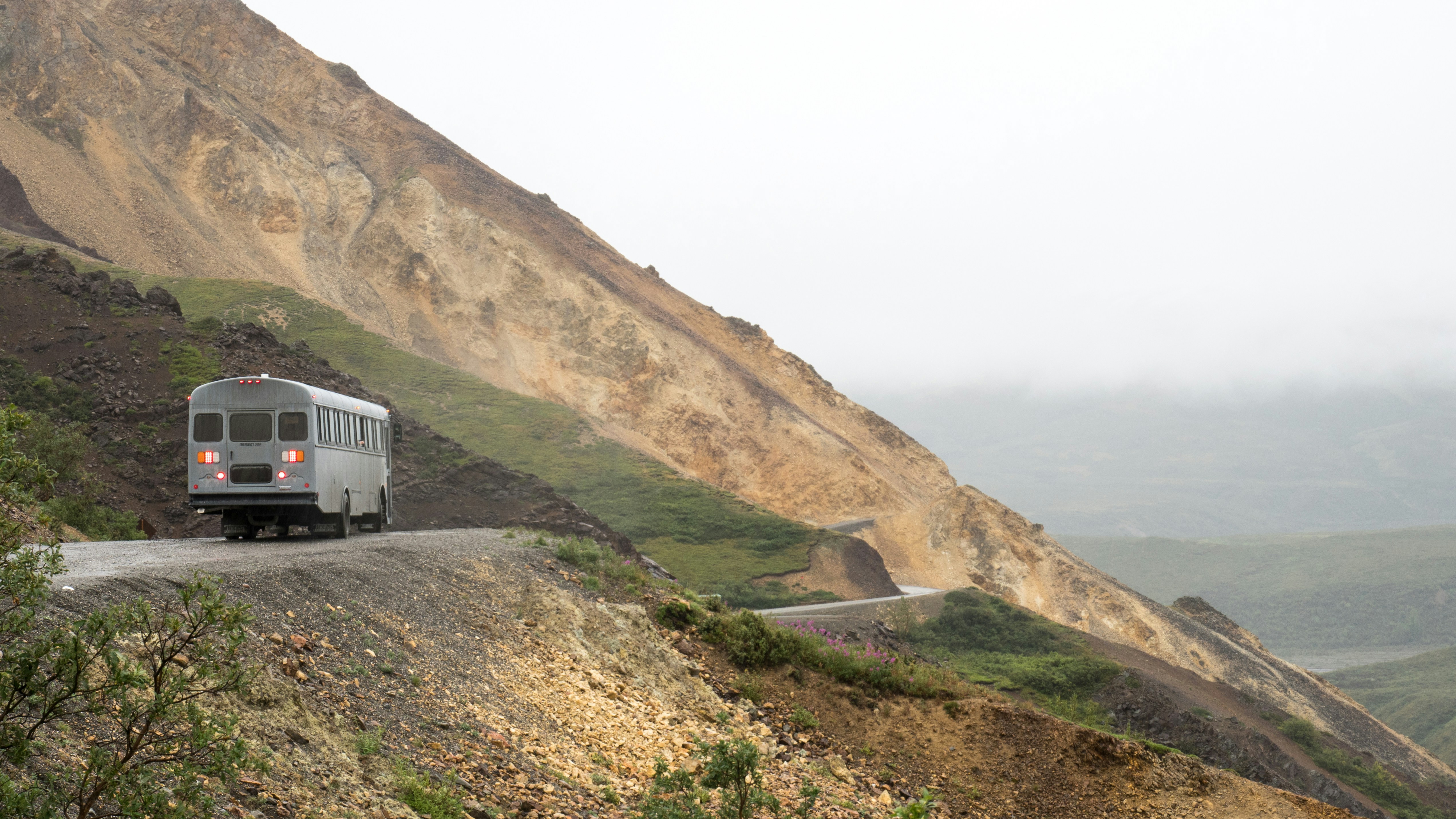 Gray transit bus on mountain road photo – Free Bus Image on Unsplash