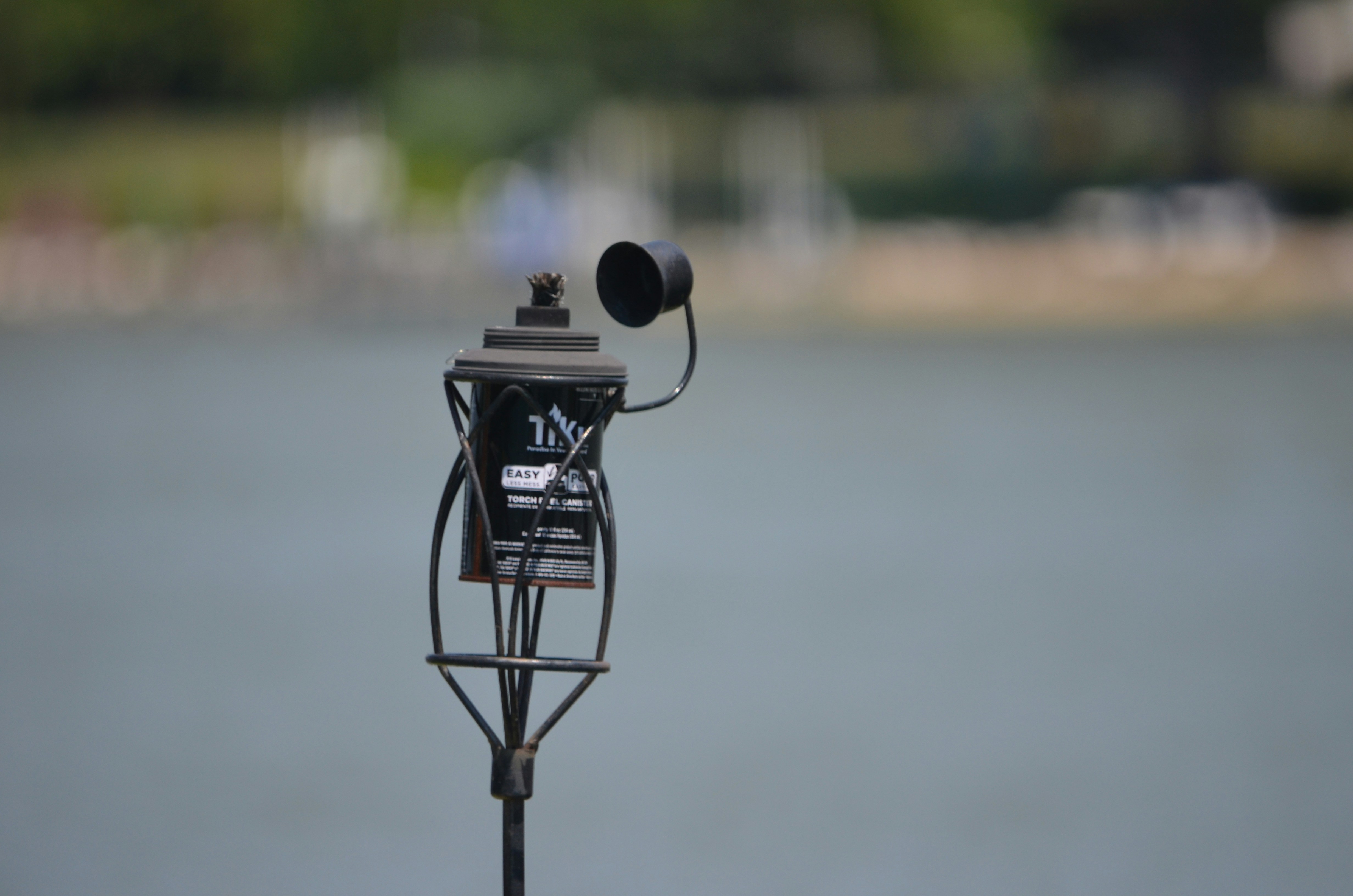 Beacon over the lake: a solitary shore device framed by calm water