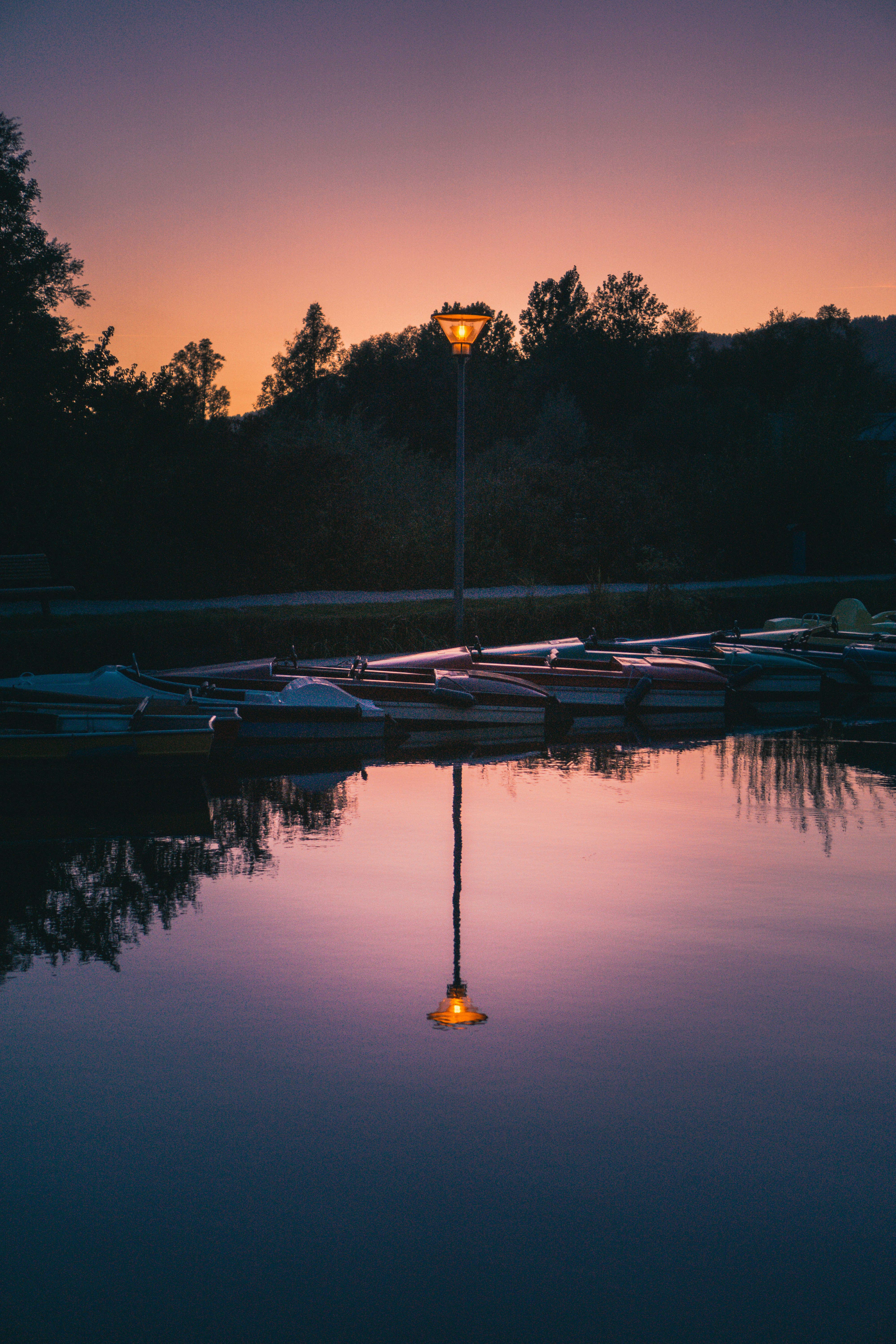 Dusk Lantern Over a Quiet Marina: Reflections in Glassy Water