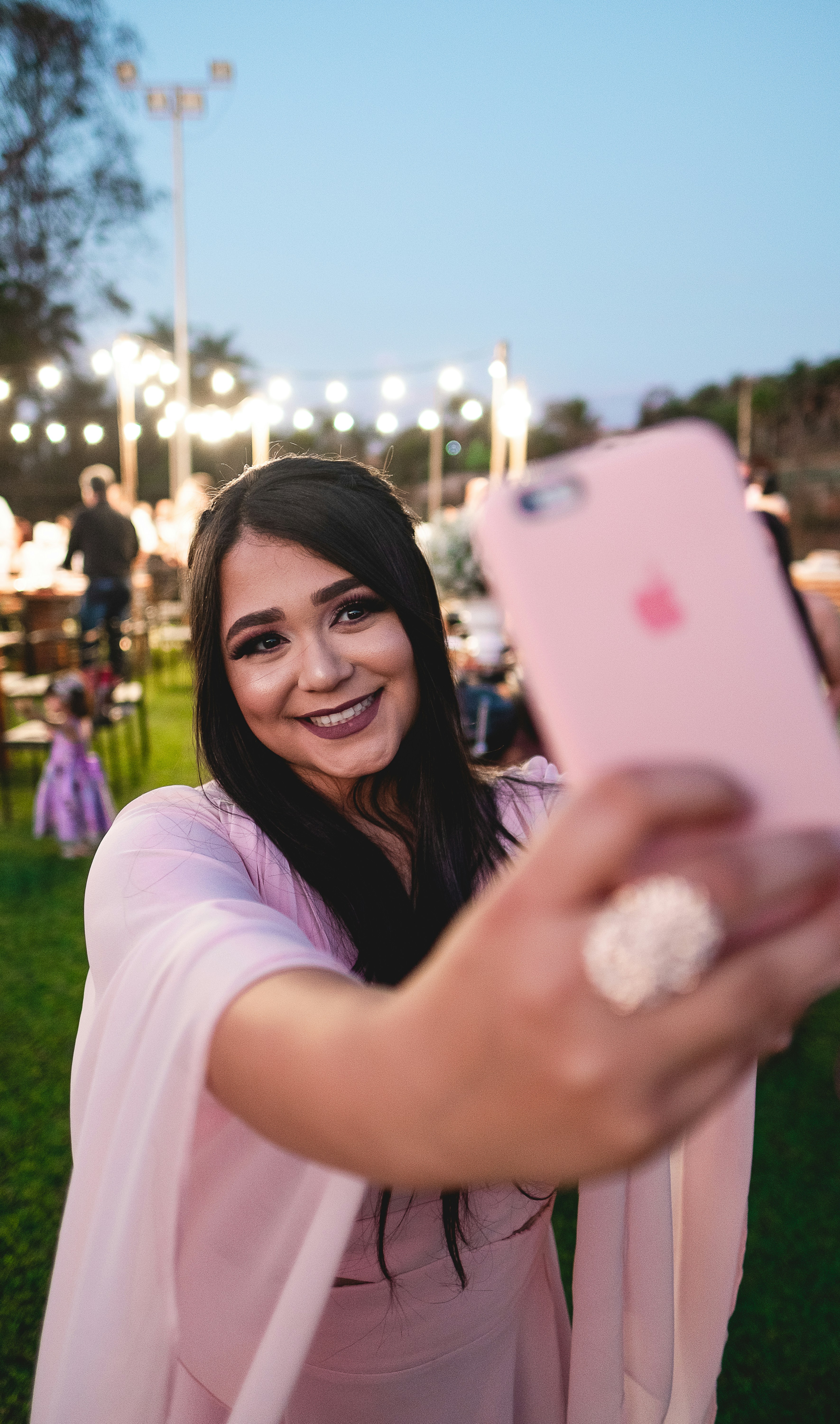 Selfie at Twilight: A Smiling Moment Under Festoon Lights