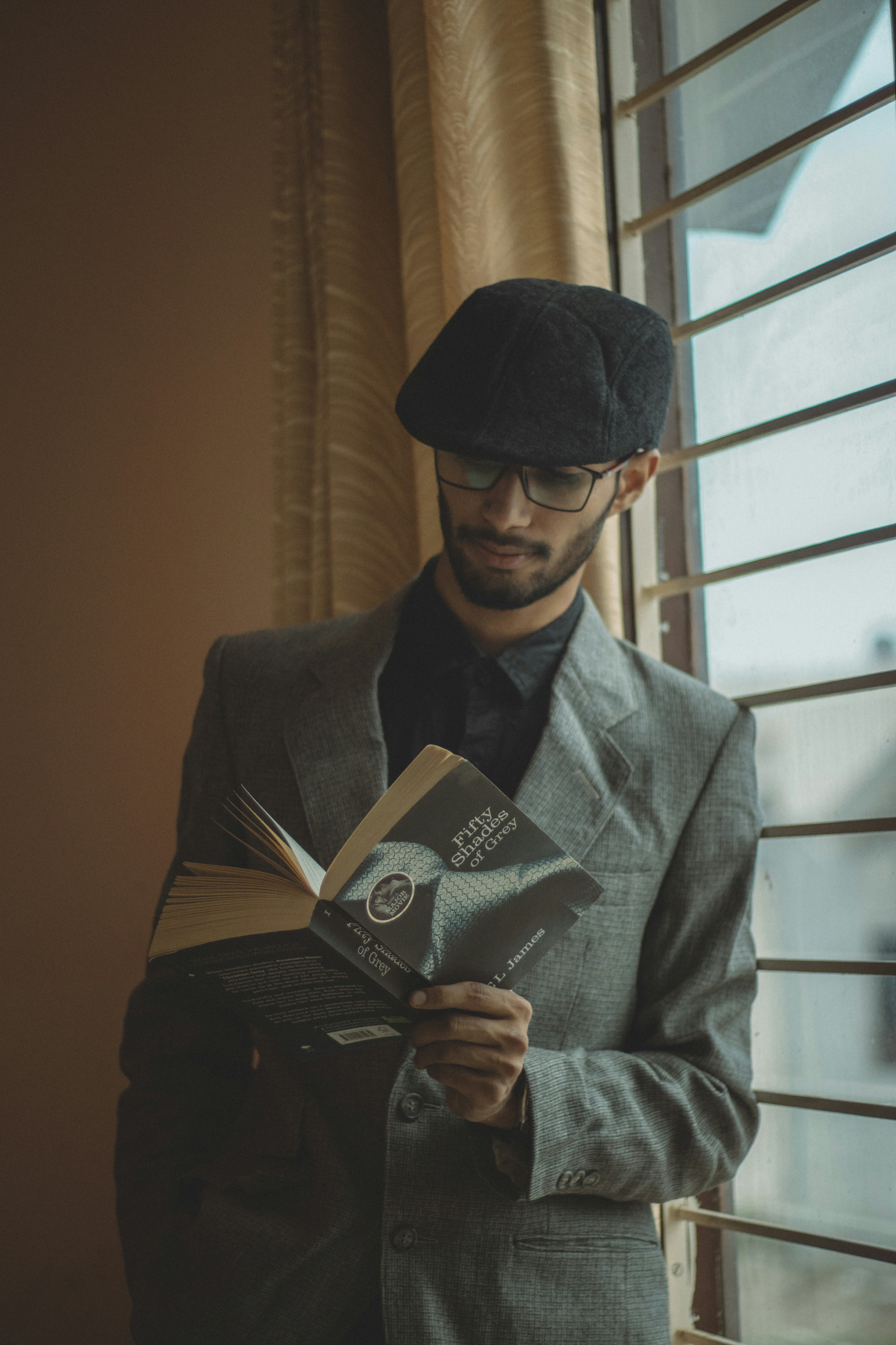Gentleman in a Fedora Reading by Window Light
